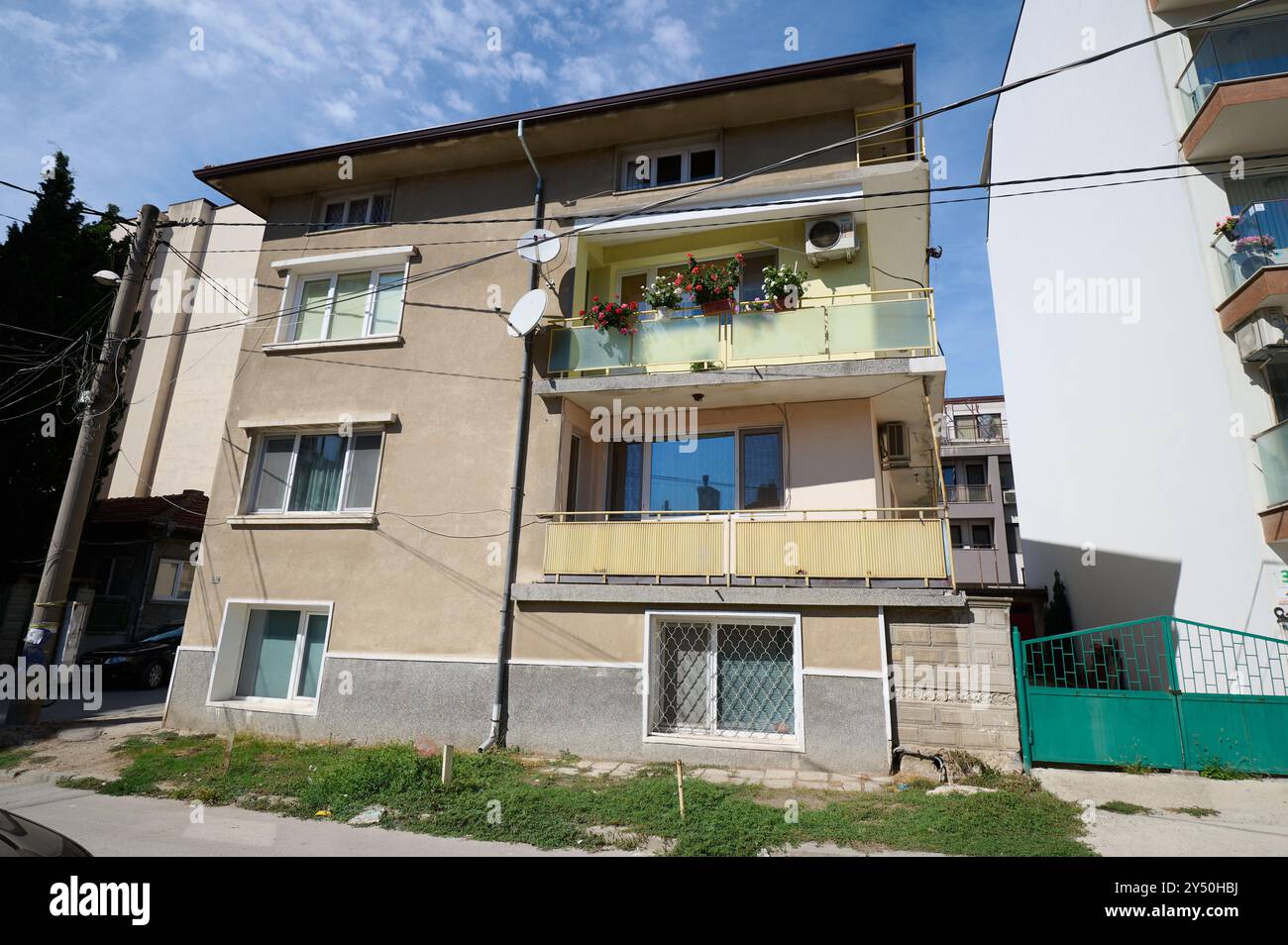 Elegantly designed residential building with a balcony and vibrant ...