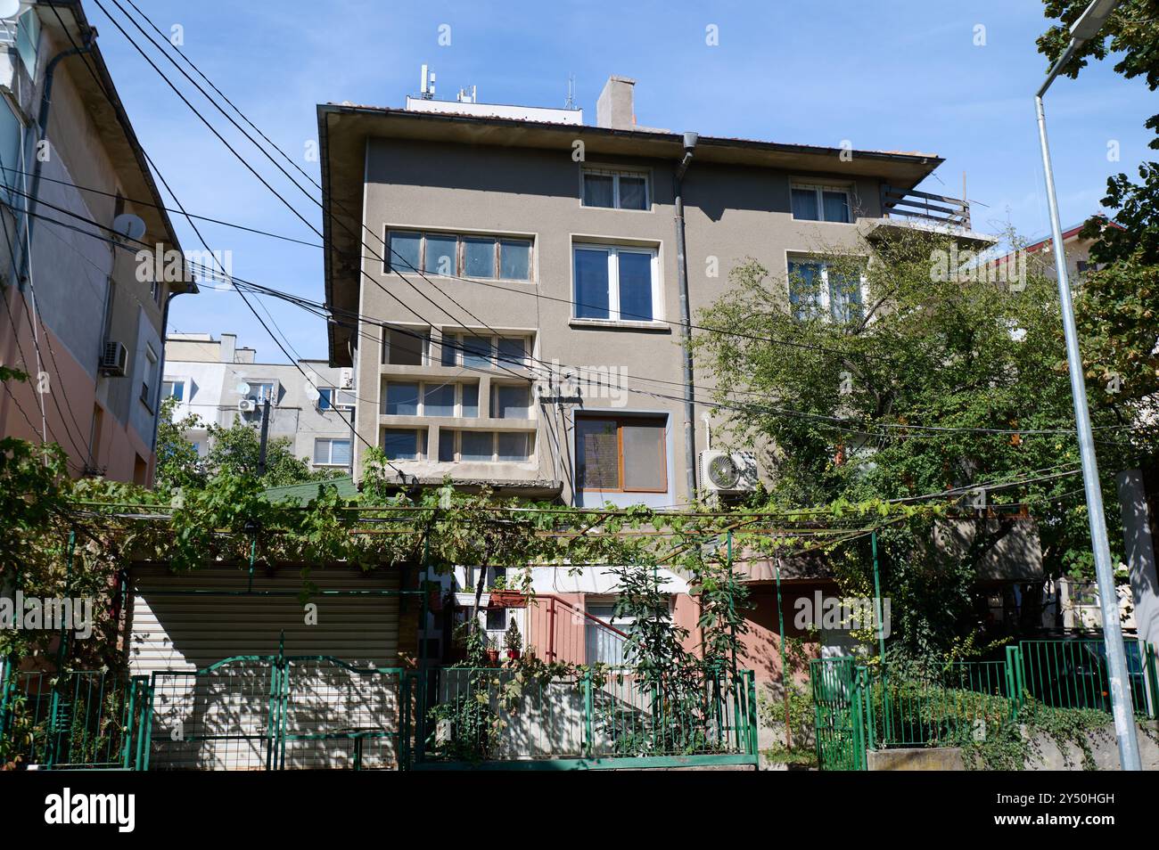 Modern residential architecture in a bustling urban neighborhood under ...