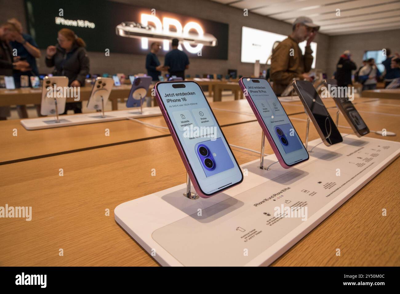 Dozens of eager consumers lined up outside the Apple Store on ...