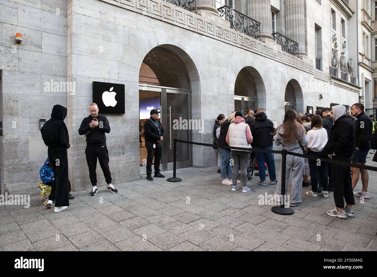 Dozens of eager consumers lined up outside the Apple Store on ...