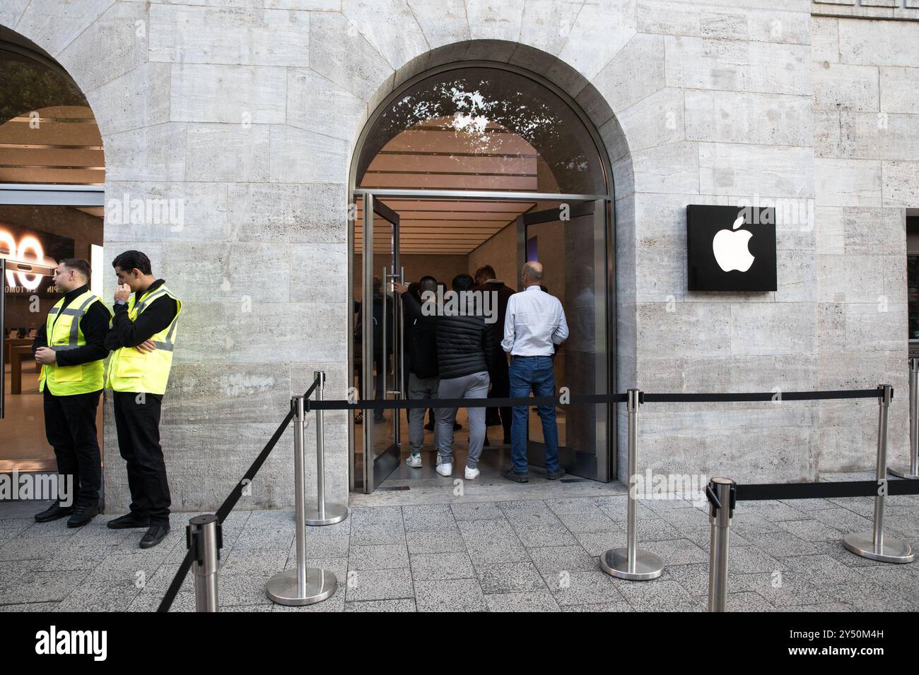 Dozens of eager consumers lined up outside the Apple Store on ...