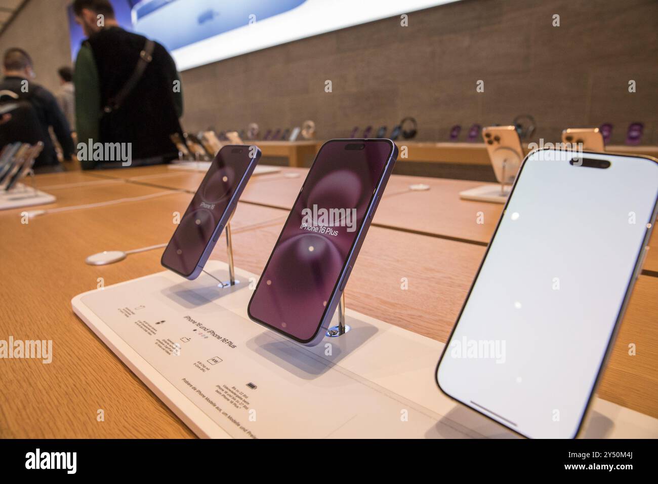 Dozens of eager consumers lined up outside the Apple Store on ...