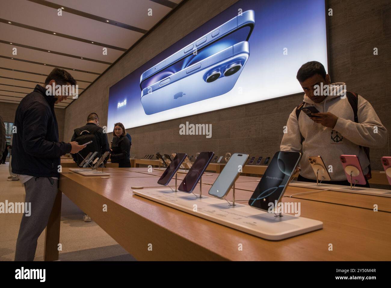 Dozens of eager consumers lined up outside the Apple Store on ...