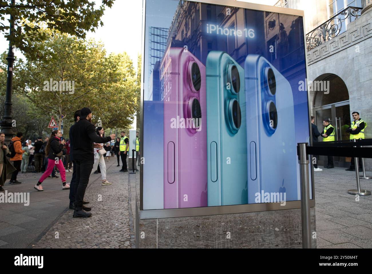 Dozens of eager consumers lined up outside the Apple Store on ...