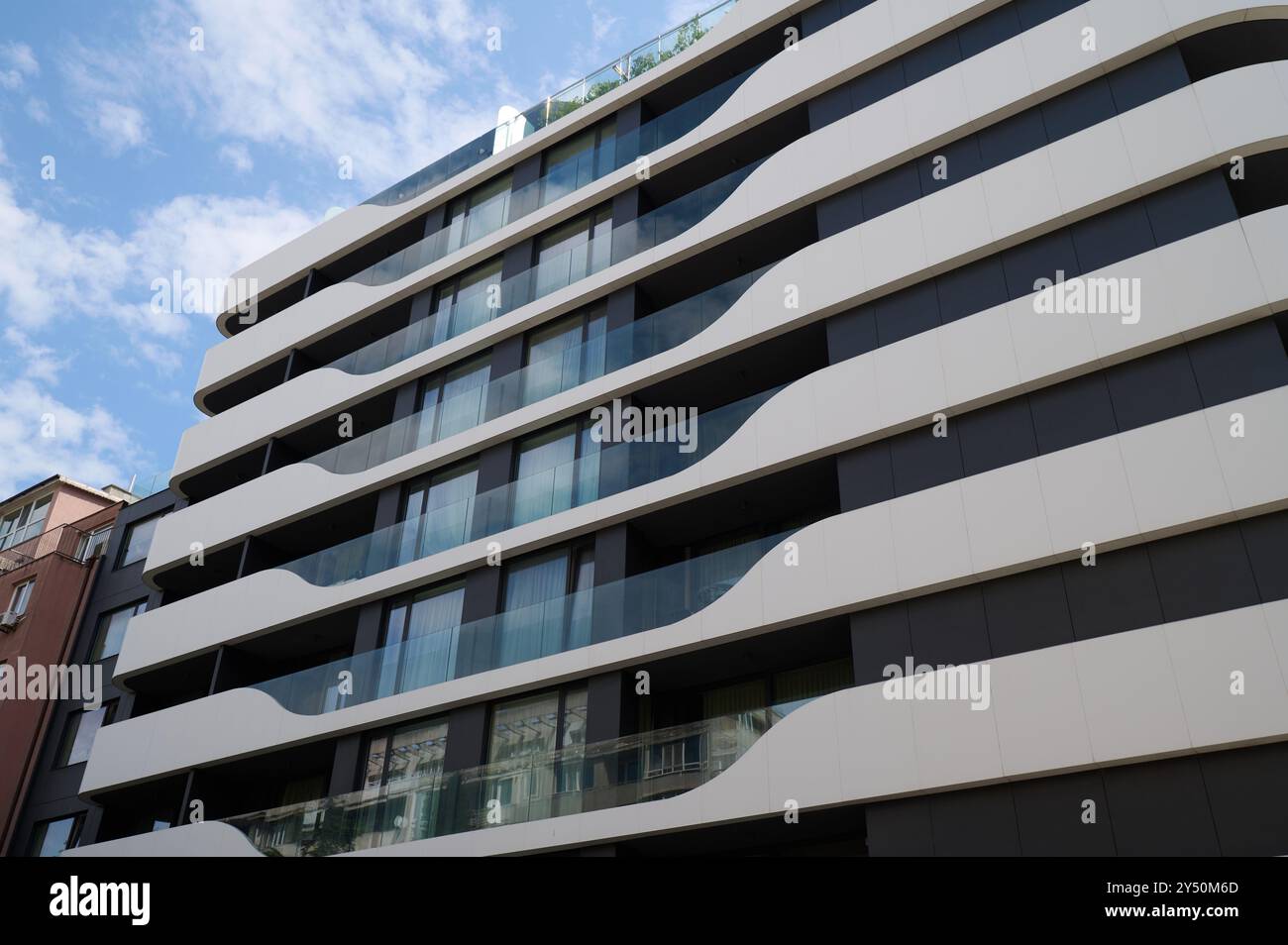 Modern residential building showcasing wavy architectural design ...