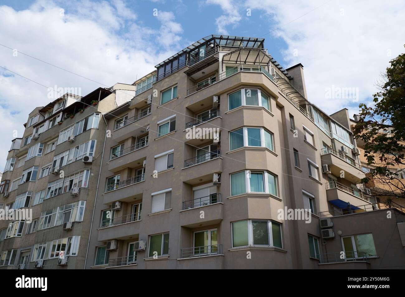 Modern residential building with distinctive curved balconies under a ...
