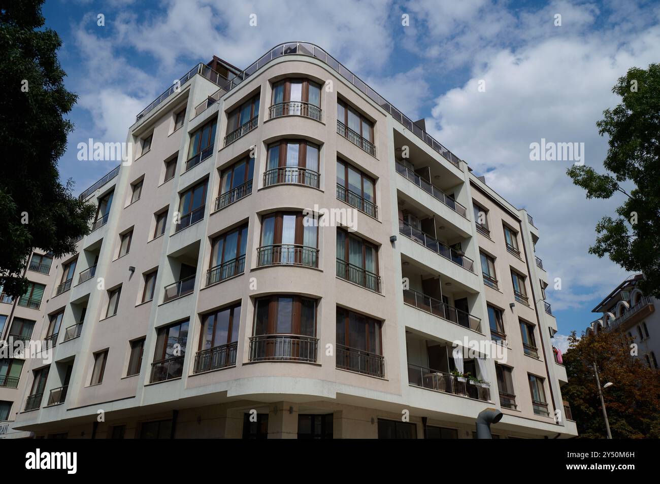 Modern apartment building showcasing curved architecture in an urban ...