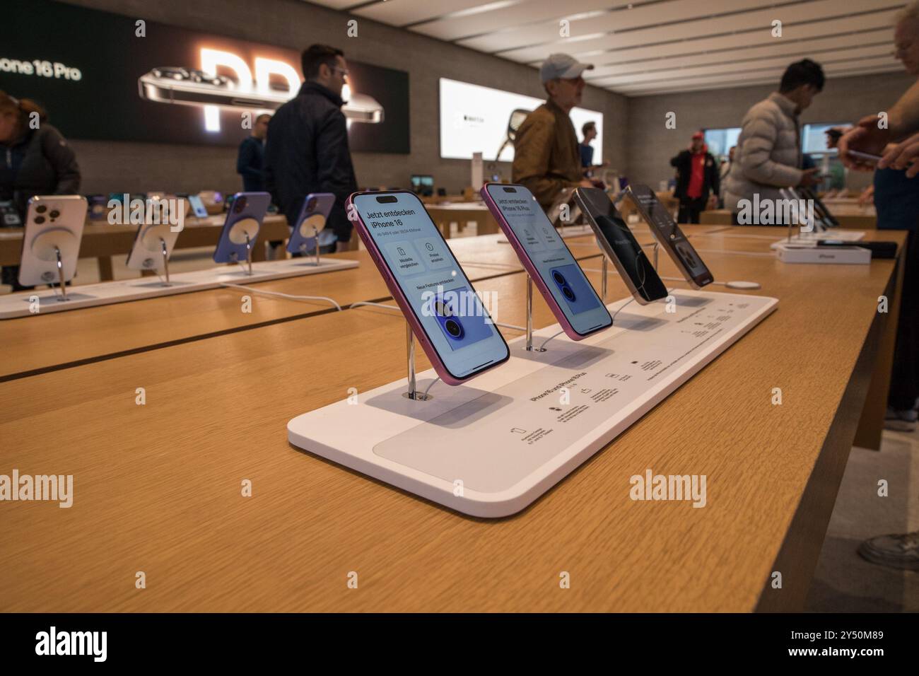 Dozens of eager consumers lined up outside the Apple Store on ...