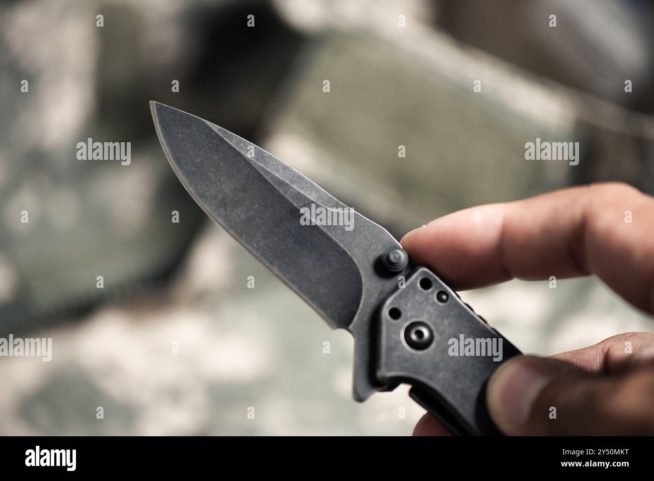 Close up the man hand using stainless steel pocketknife Stock Photo - Alamy