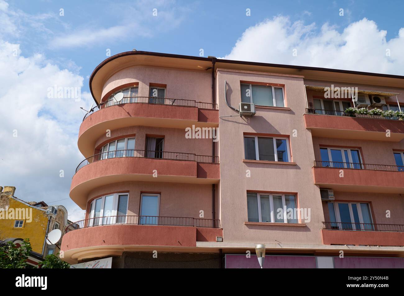 Modern residential building featuring curved balconies in a vibrant ...