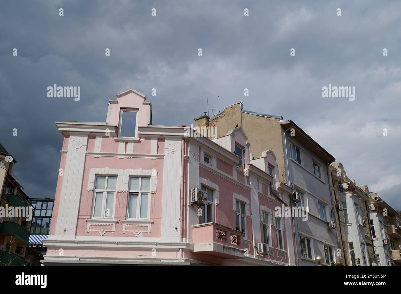 Elegant pink building showcasing distinct architectural style under a ...