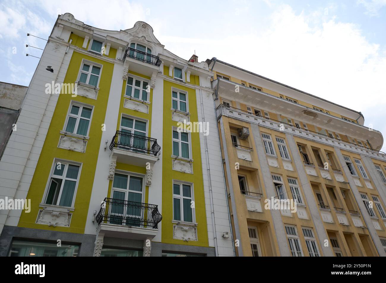 Vibrant yellow building showcases unique architectural style in a ...
