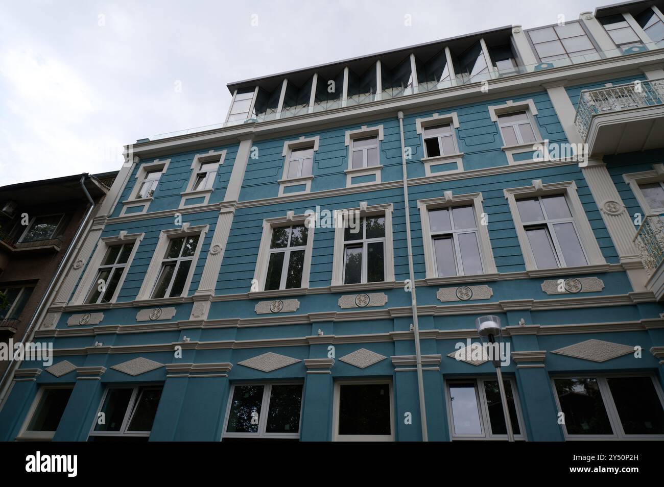 Historic blue facade of a restored building in an urban setting ...