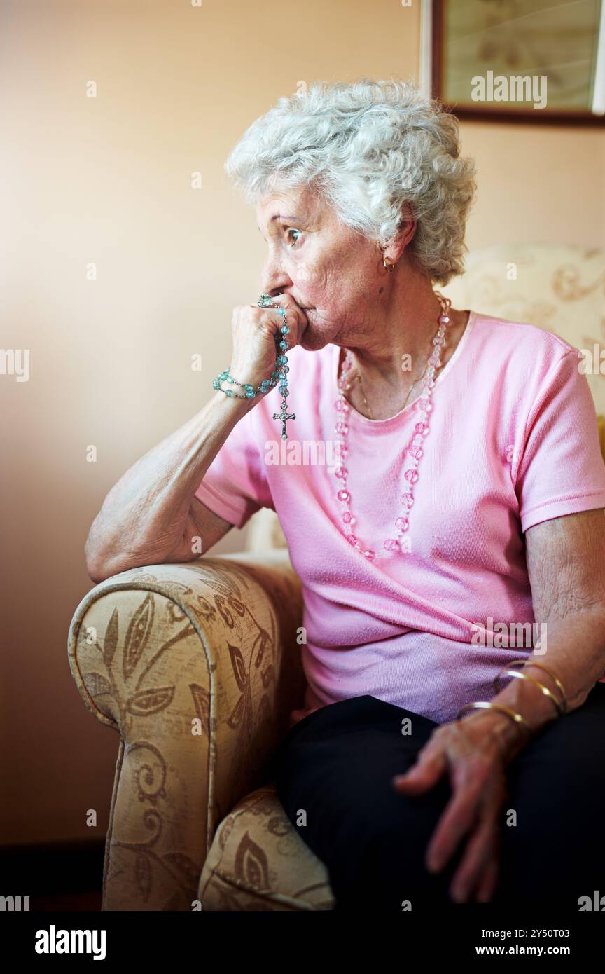 Old woman, prayer and rosary beads in home, spiritual worship and ...