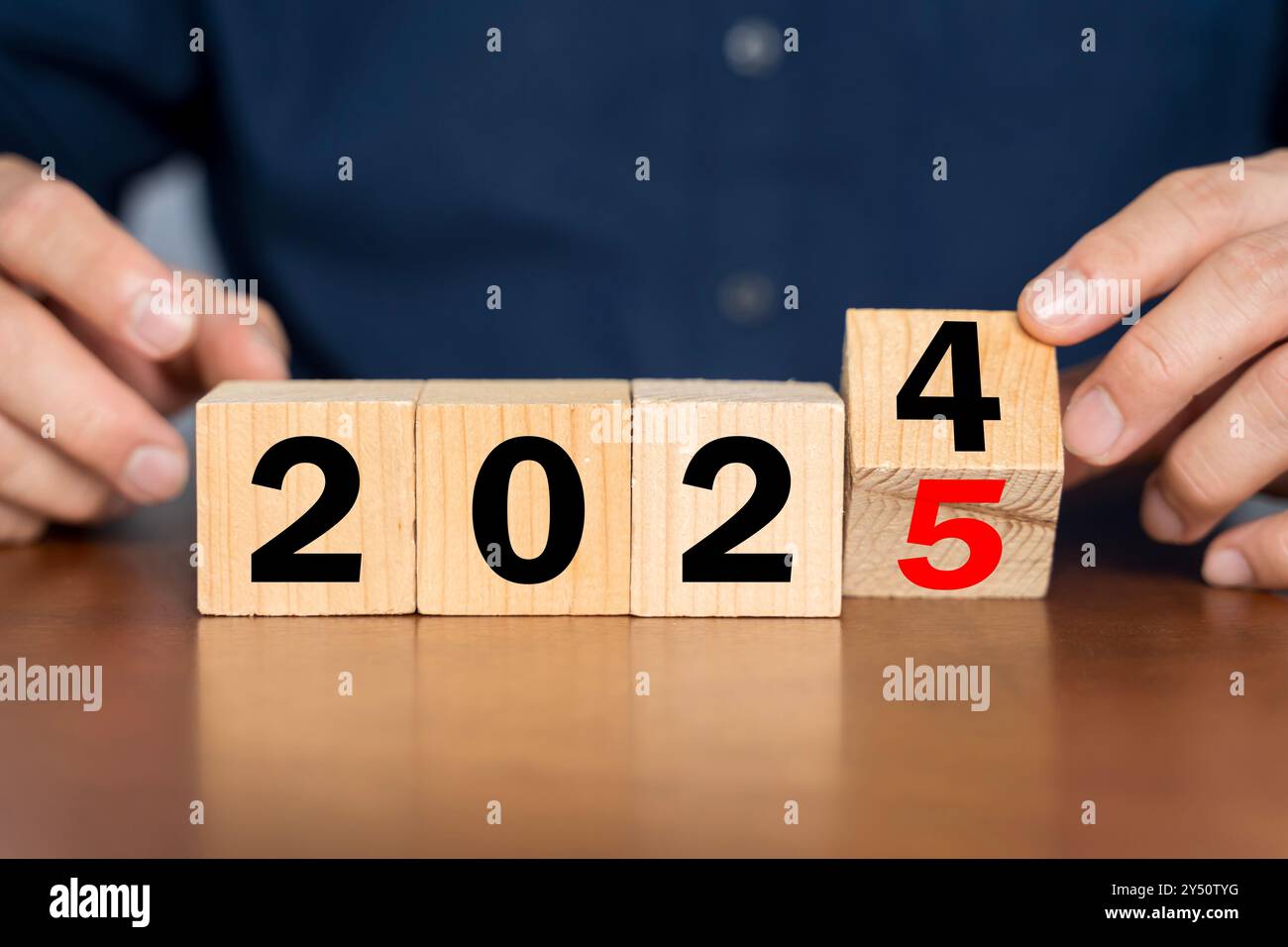 Hand flipping wooden block cube for change 2024 to 2025 for money ...