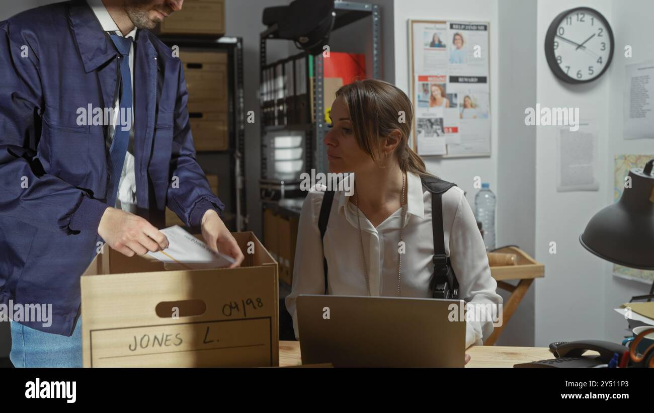 Man and woman, in detective roles, examining documents in a cluttered ...