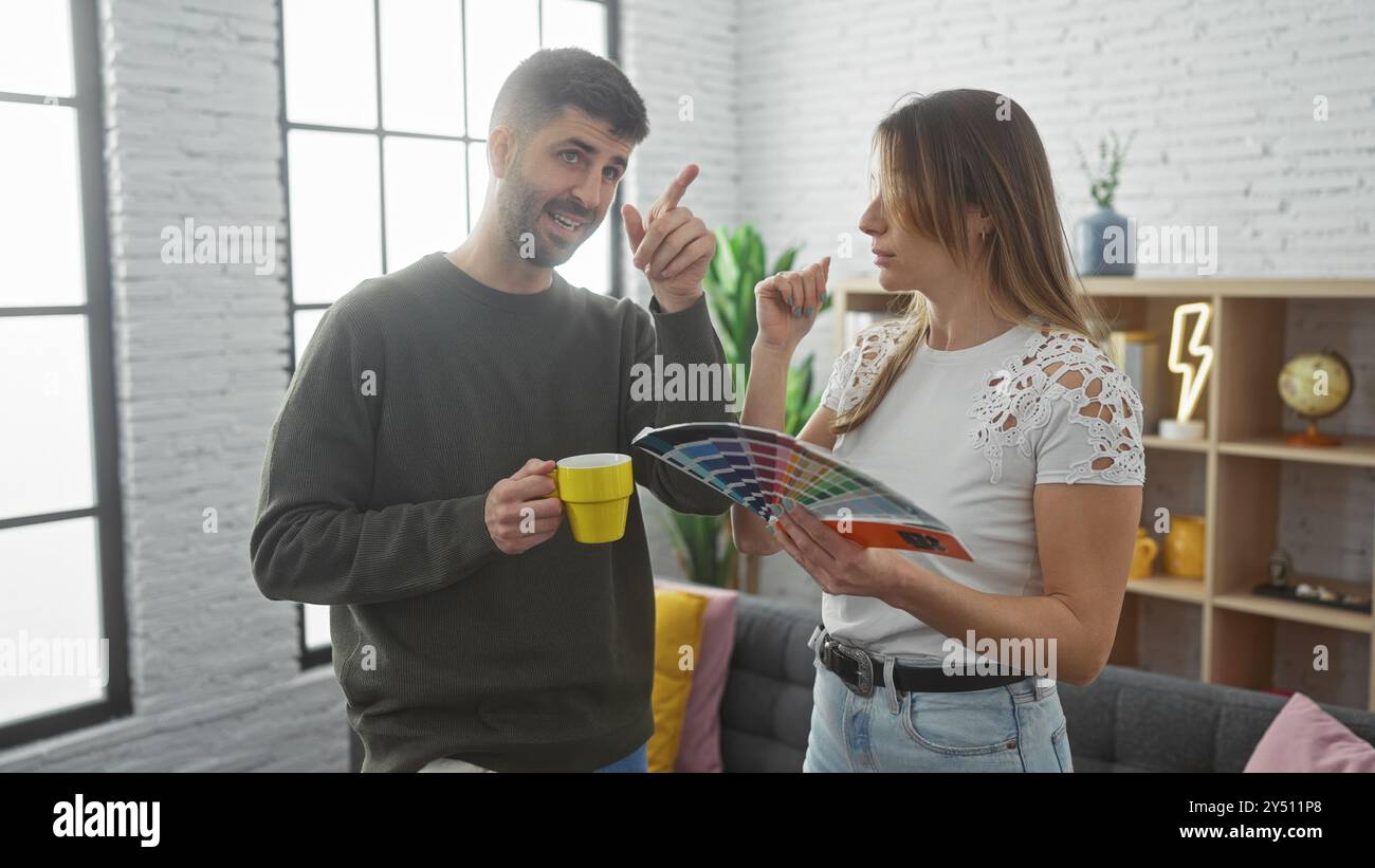 Couple choosing paint colors for their apartment interior, with man ...
