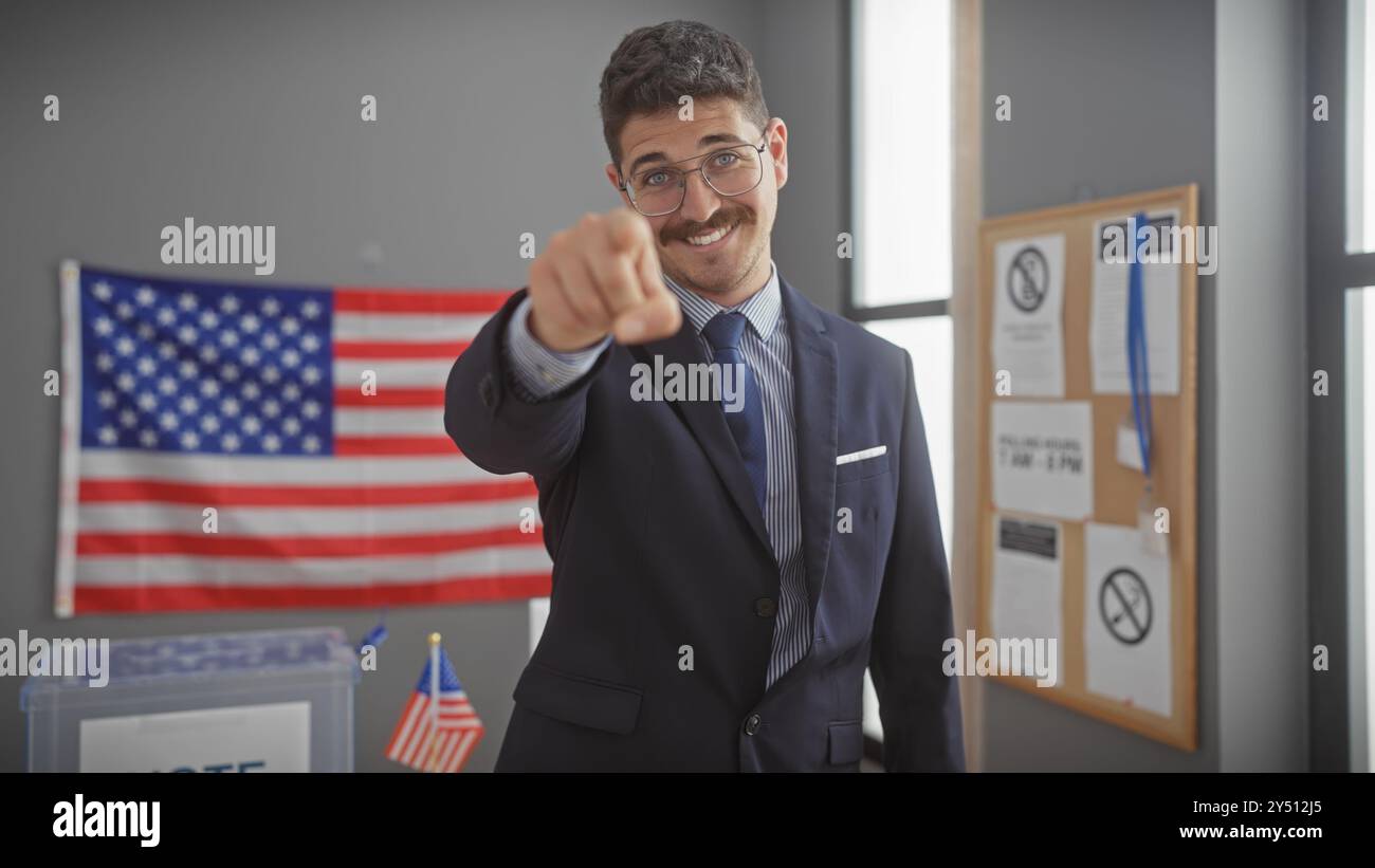 Hispanic man in suit pointing at camera in us voting center with ...
