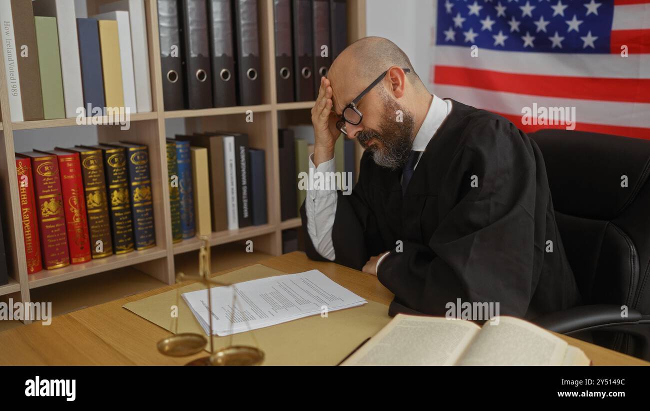 Hispanic man in a courtroom wearing judge's robes appears stressed ...
