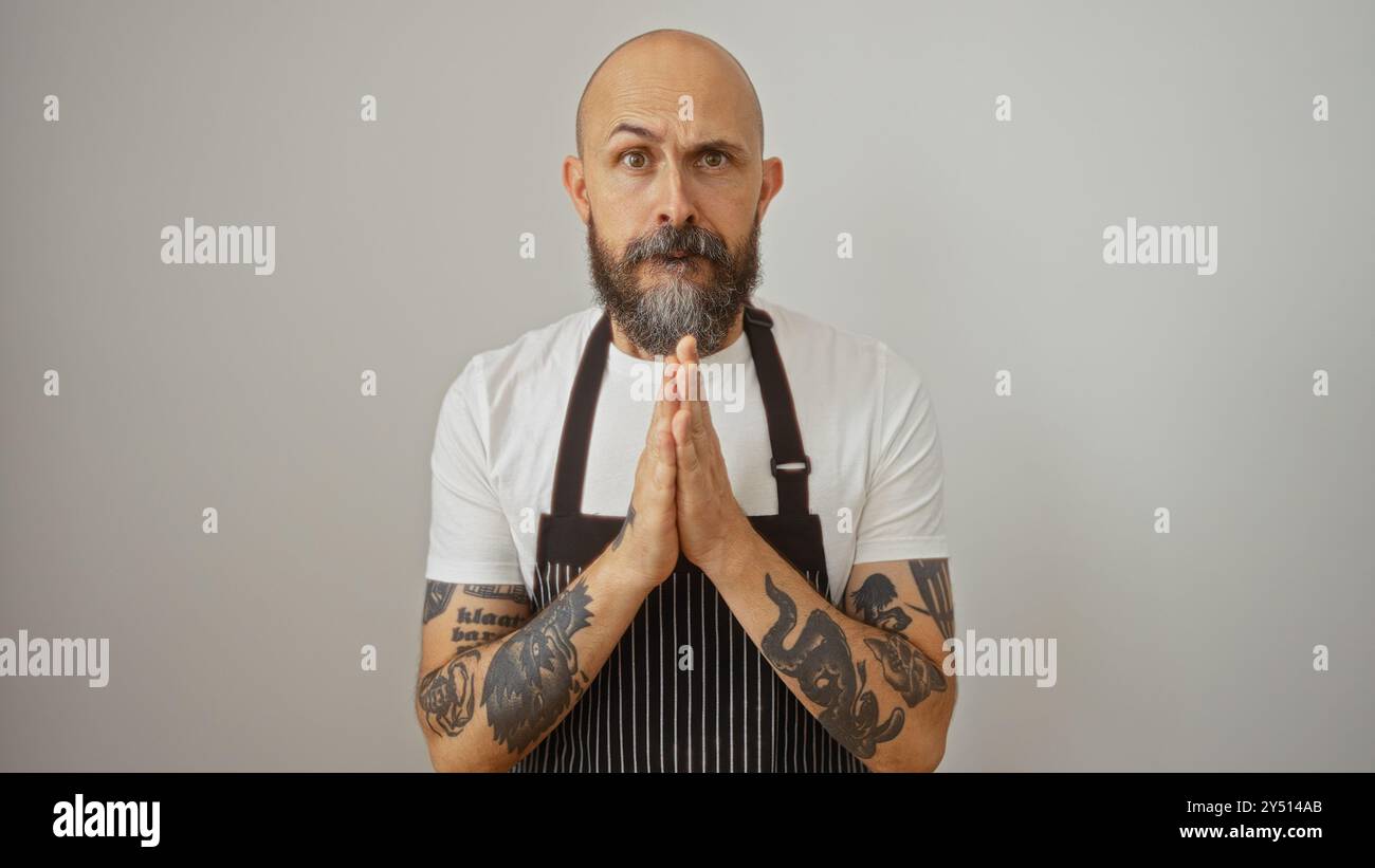Handsome hispanic man with a beard and tattoos, wearing a white shirt ...