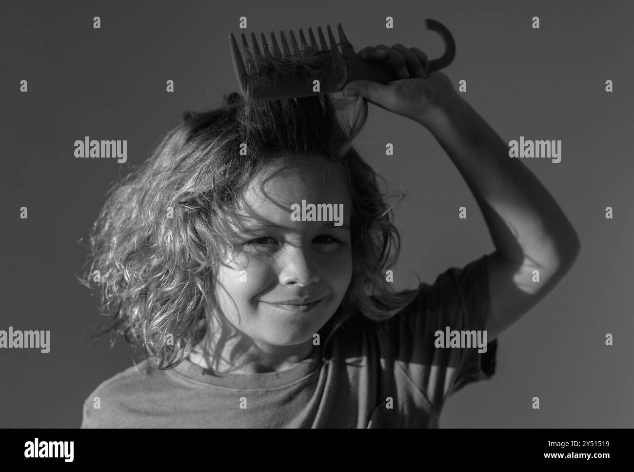 Kids hair. Closeup portrait of little child brushing hair. Little child ...