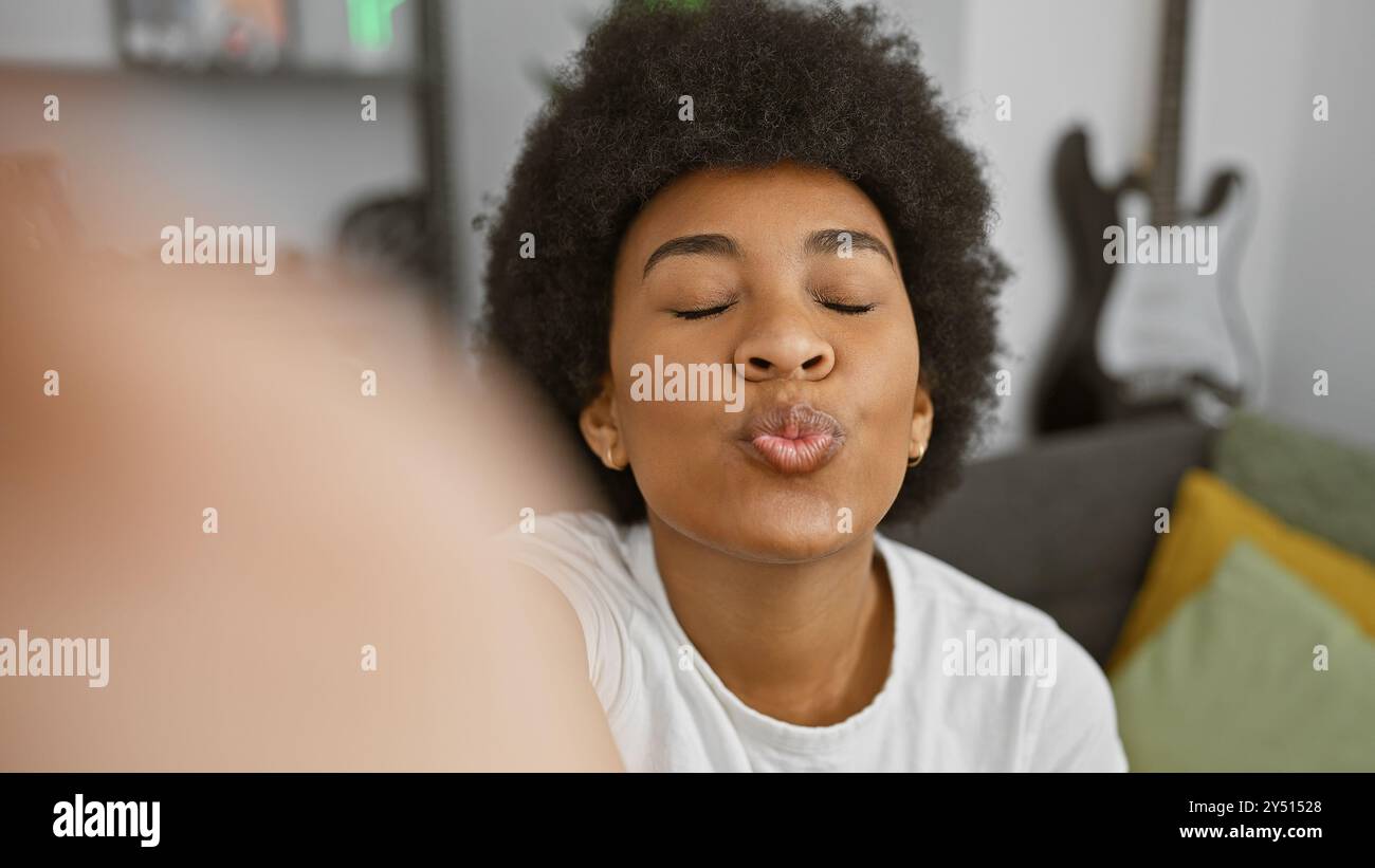 African american woman taking a selfie indoors with a pucker pose ...