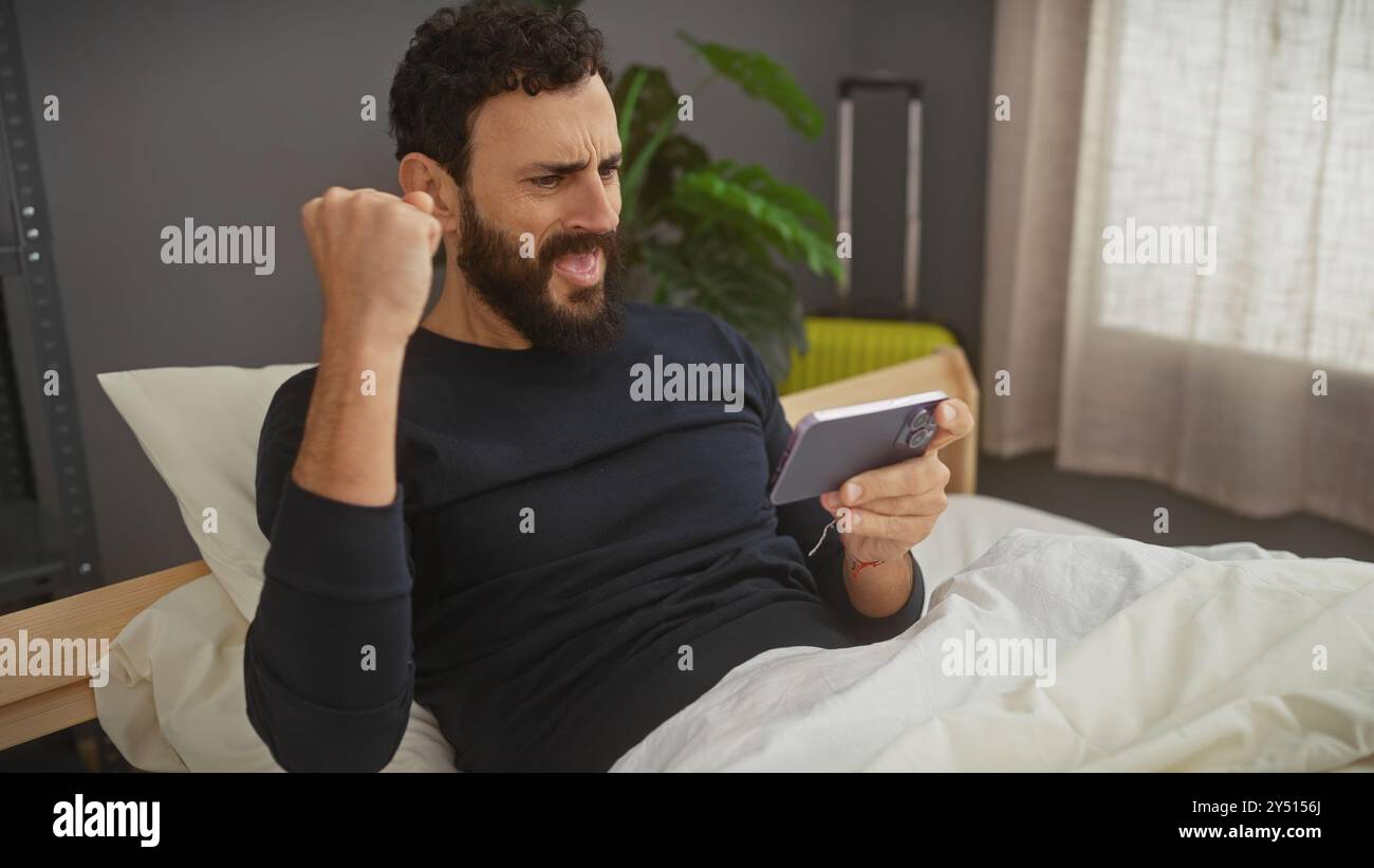 A middle-aged man with a beard shows excitement while looking at his ...