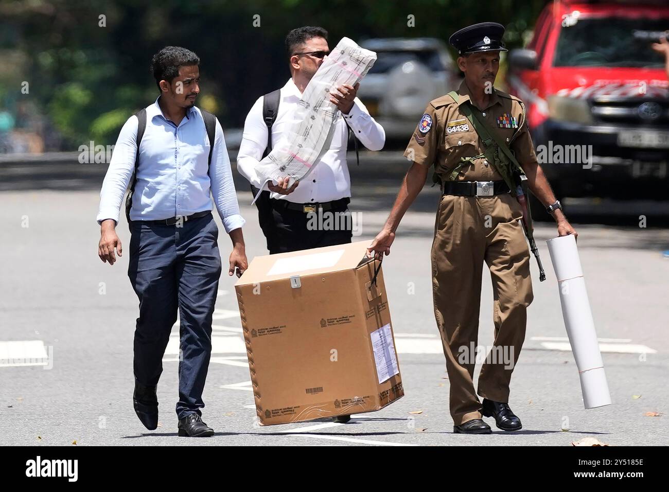 Election officials leave a distribution center after collecting polling ...