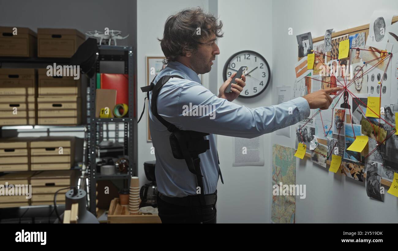 A young detective analyzes evidence on a board at a police station ...