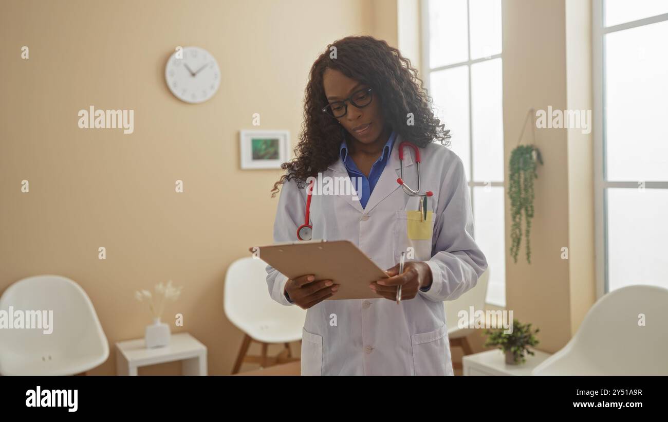 A beautiful african american female doctor with curly hair reviews a ...