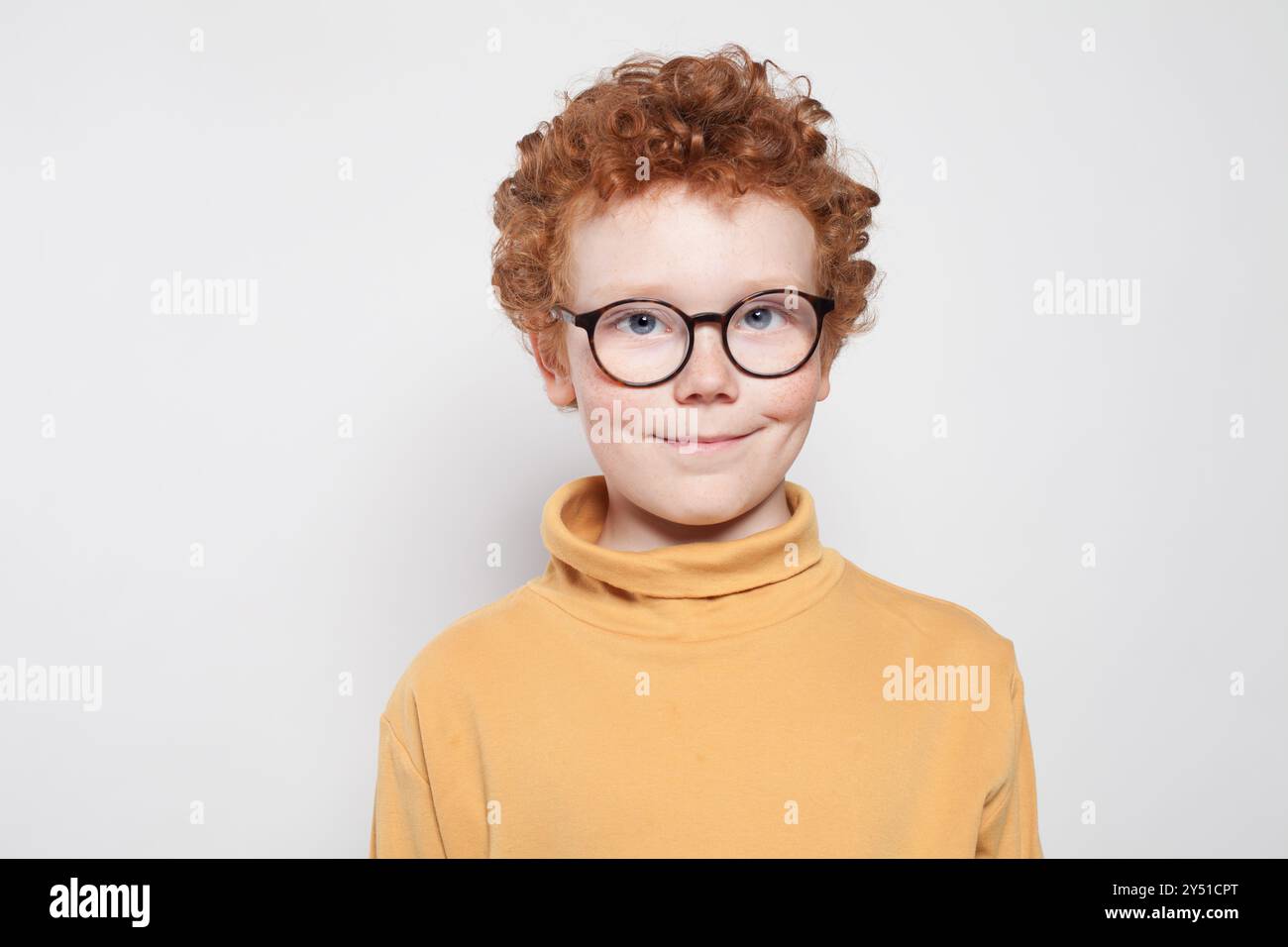 Cute redhead child school boy in school uniform looking up on blackboard background Stock Photo ...