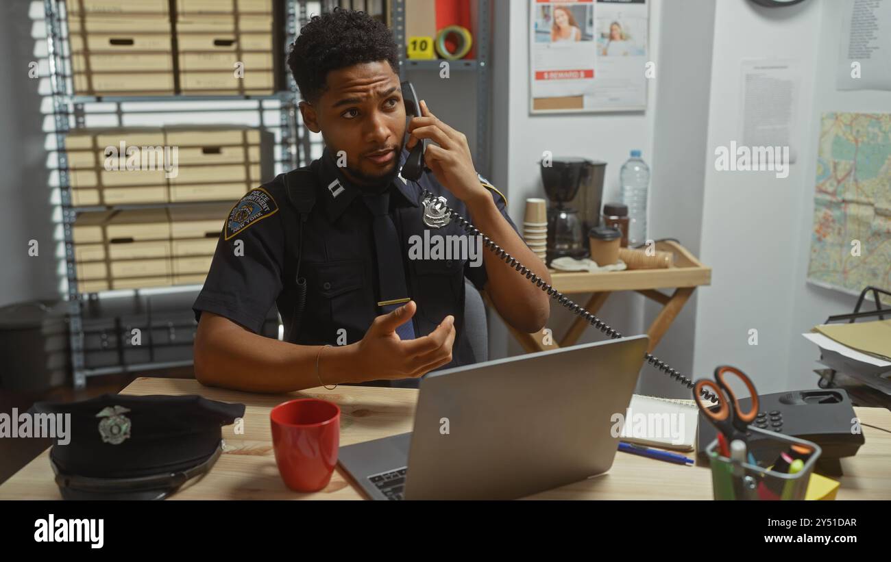 African american police officer in uniform on phone, looking concerned ...