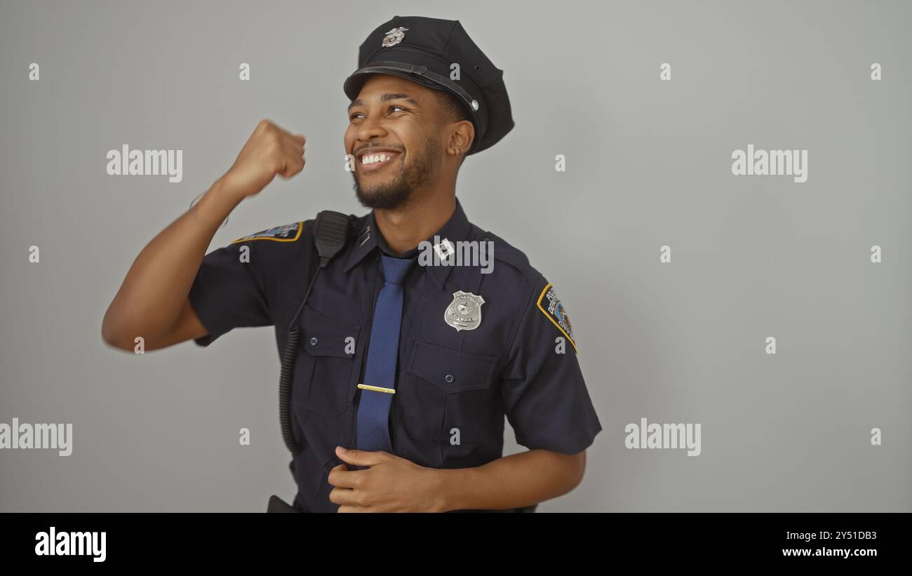 Portrait of a confident african american policeman flexing and smiling ...