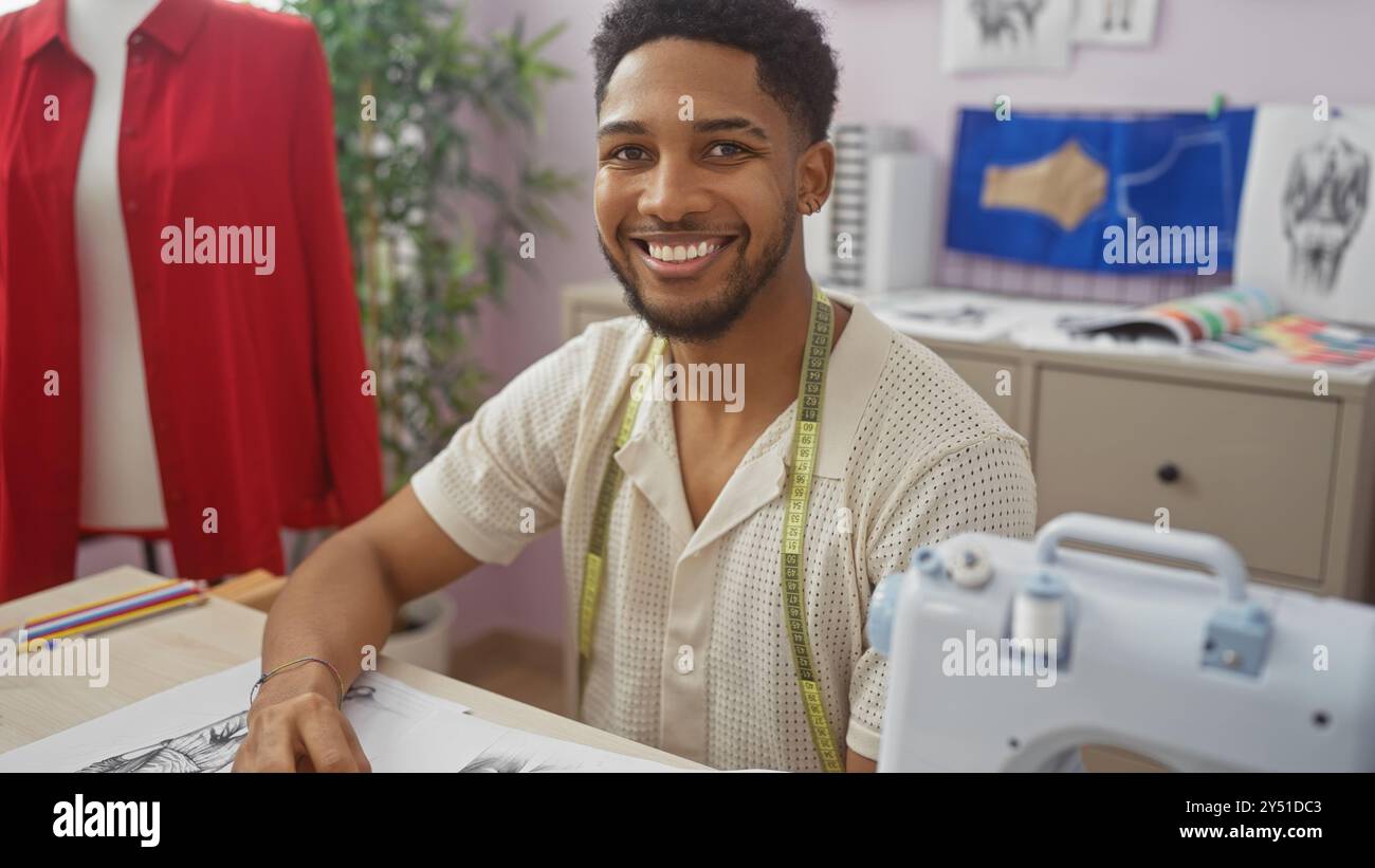 African american tailor smiling in a design studio with mannequin ...
