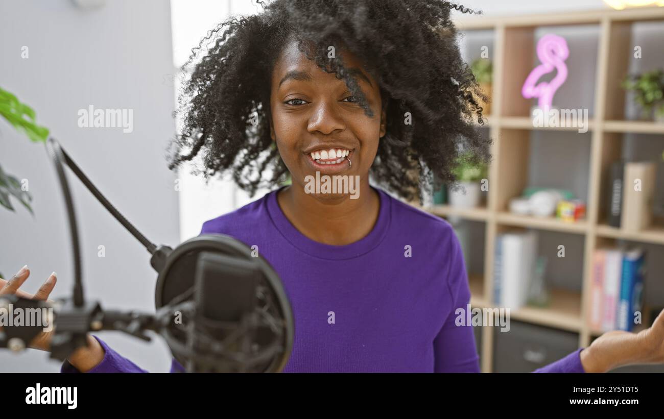 A joyful african american woman speaking into a microphone in a modern ...