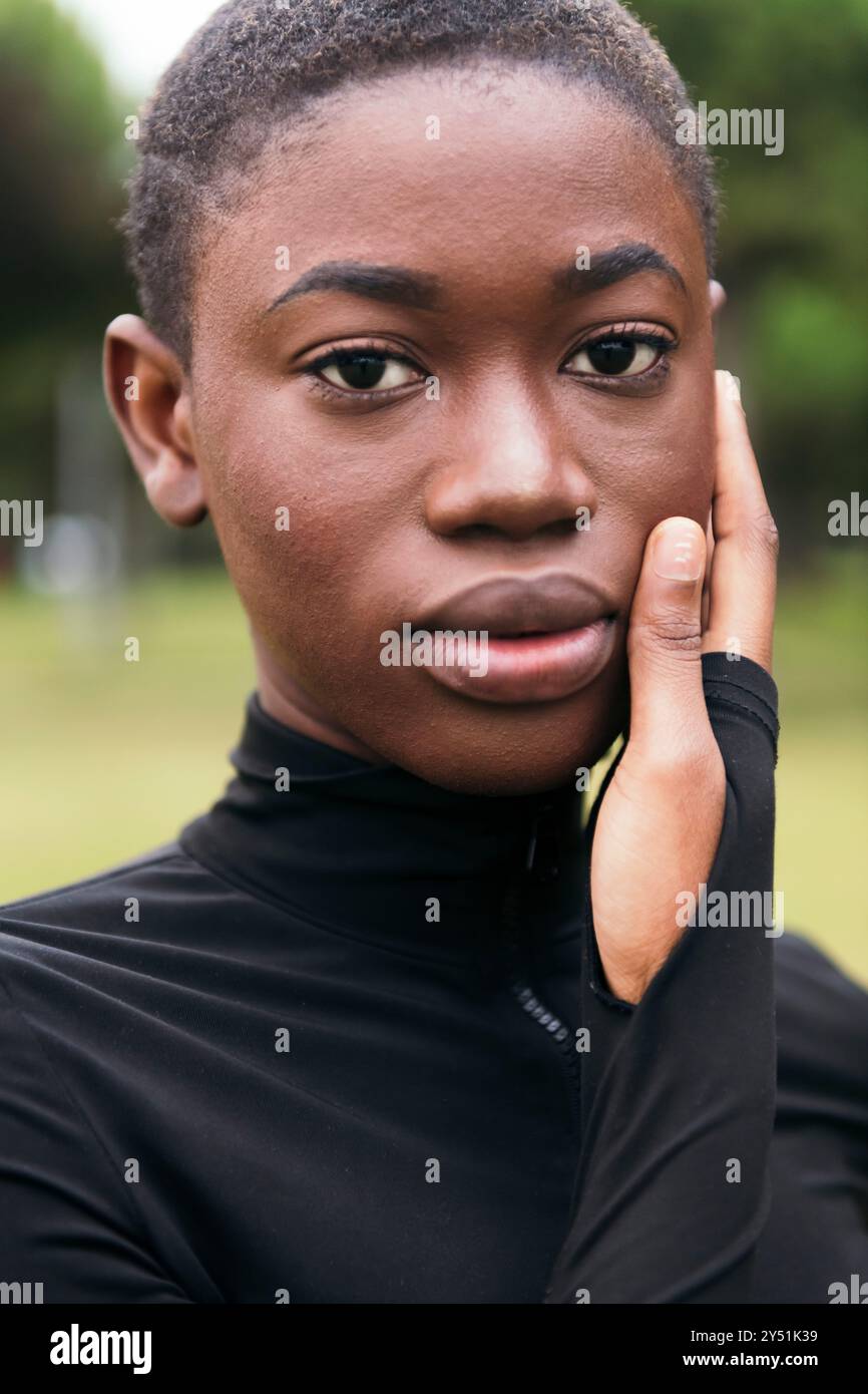 young tender ethnic female touching face with hand Stock Photo - Alamy