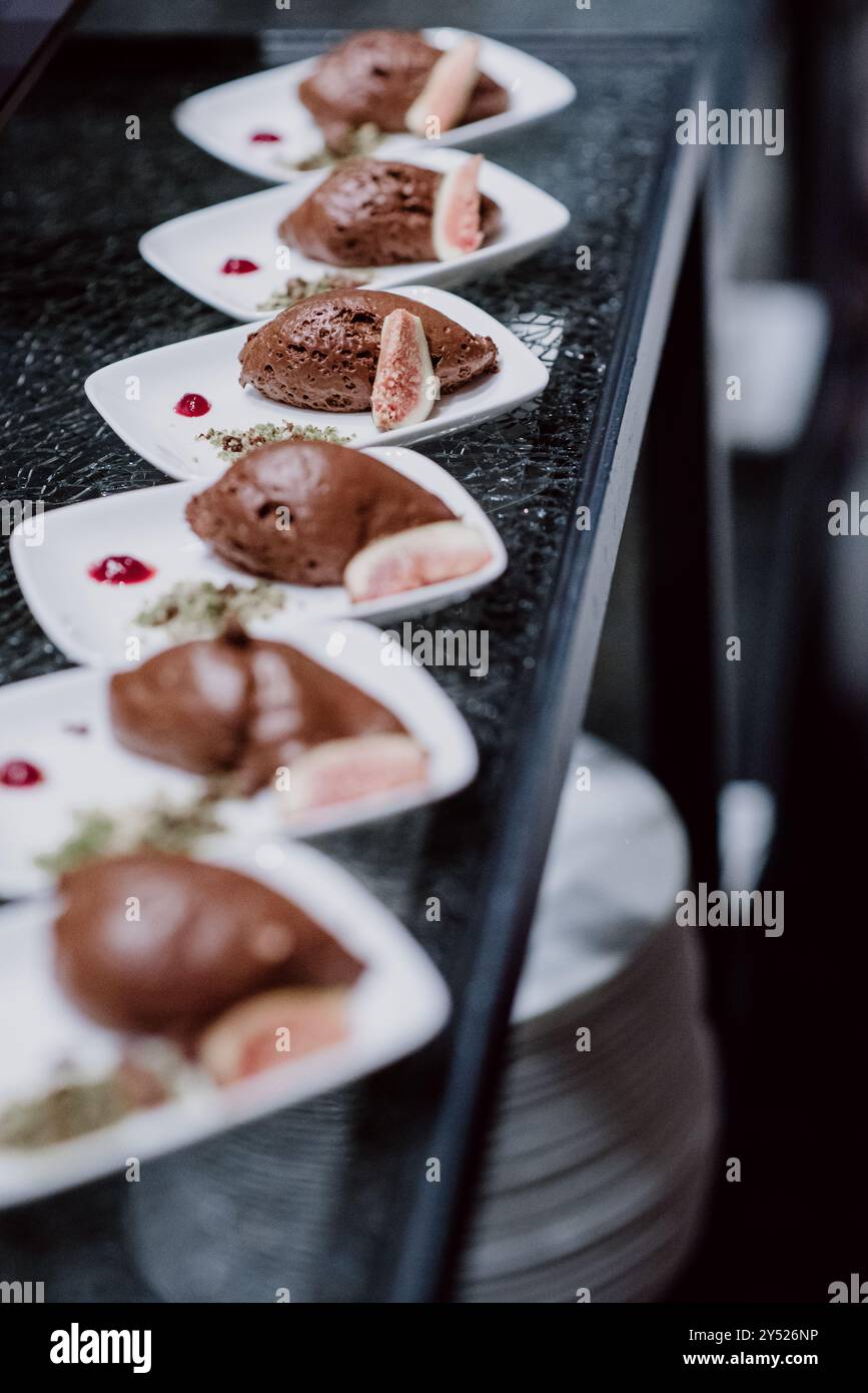 Plated chocolate mousse with figs and decorative garnish in a buffet ...