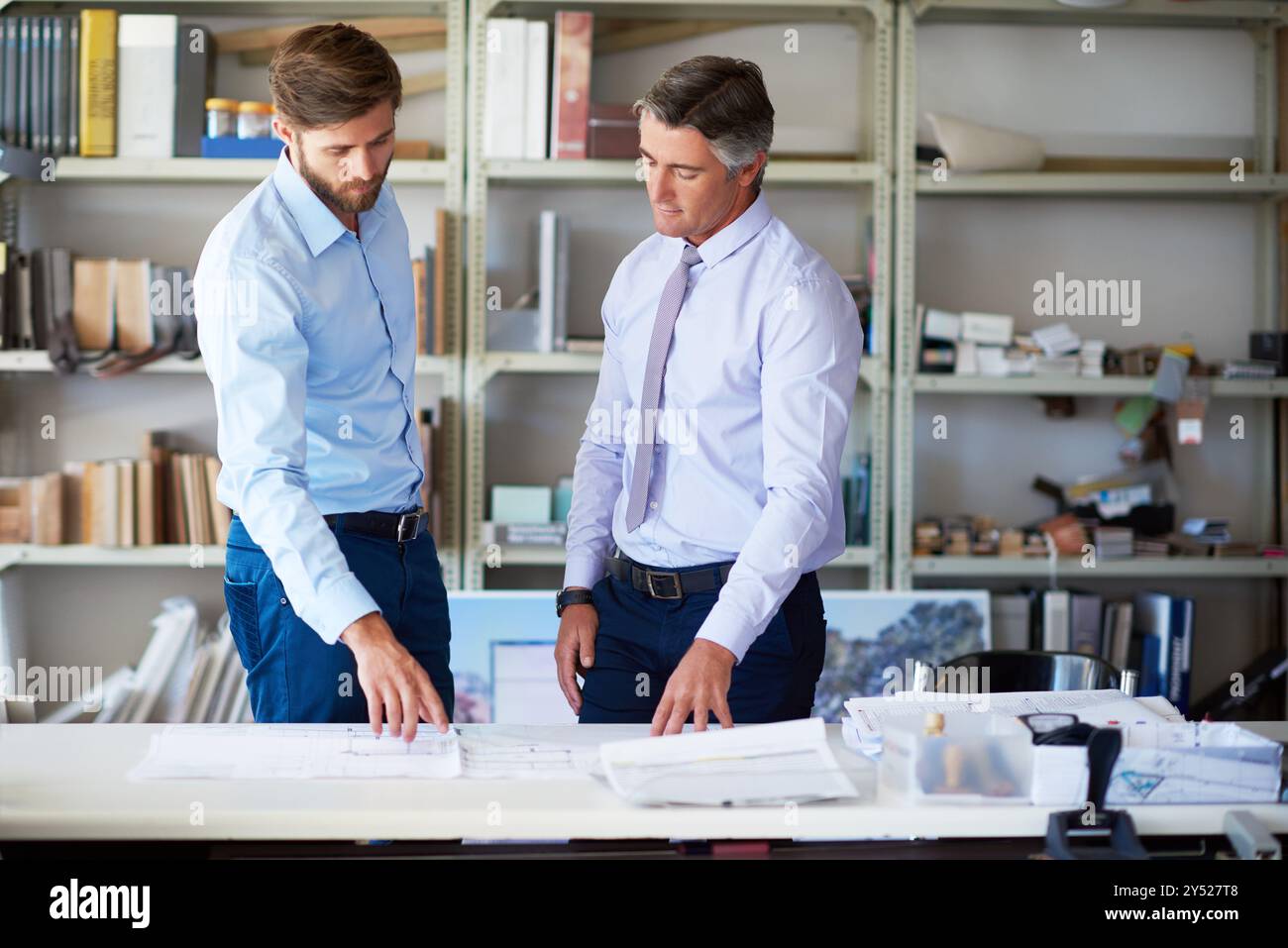 Business men, blueprint and project collaboration in office with ...