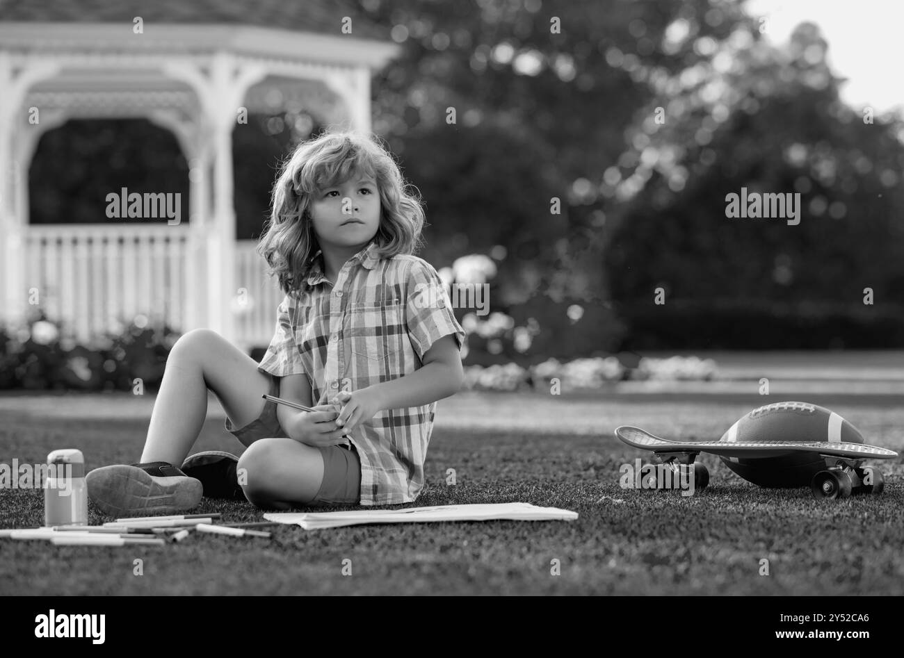 Outdoor kid play and draw craft artwork homework. Clever school boy ...