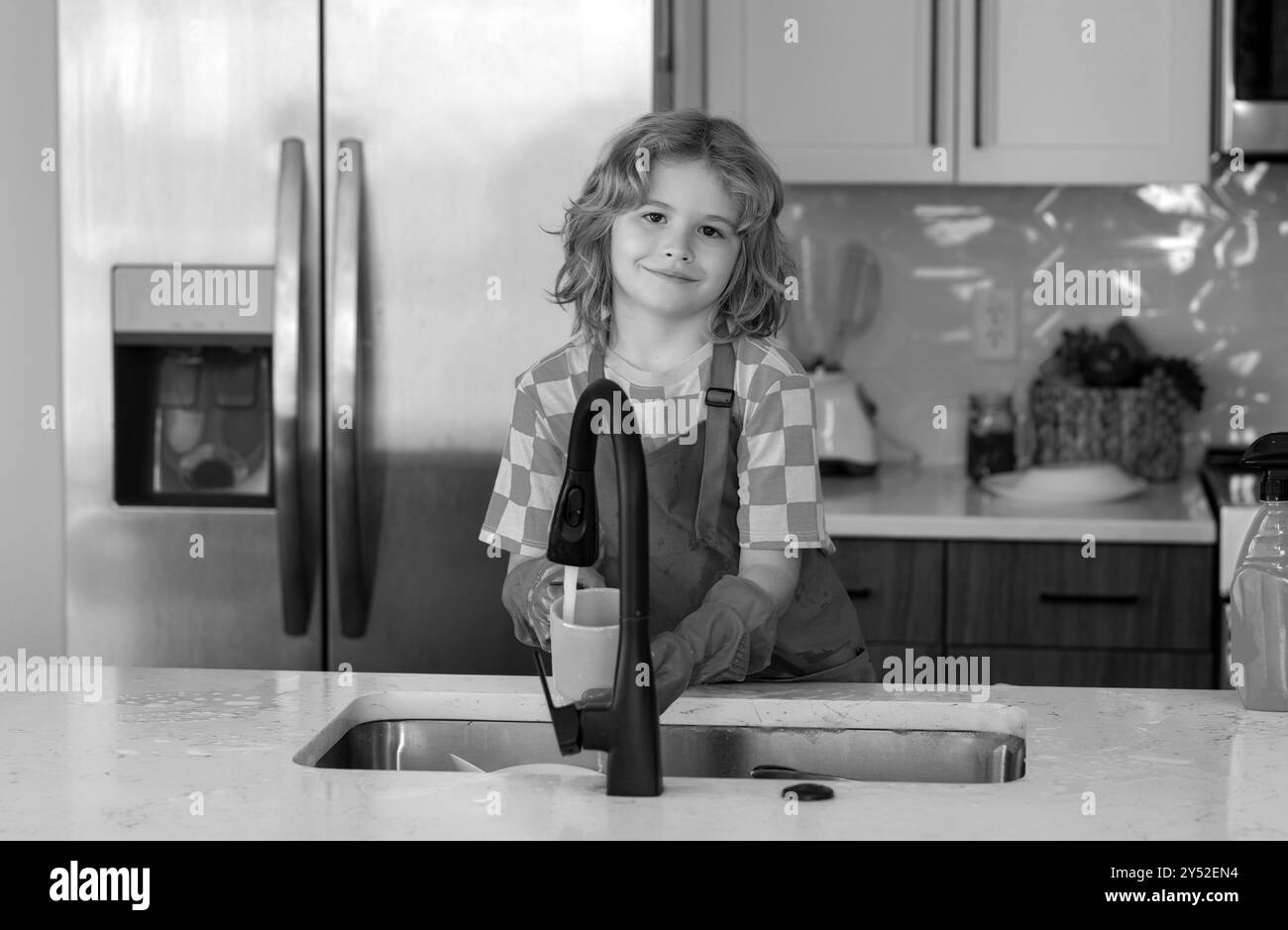 Clean washed dishes, dishwashing liquid with foam. Child helper ...