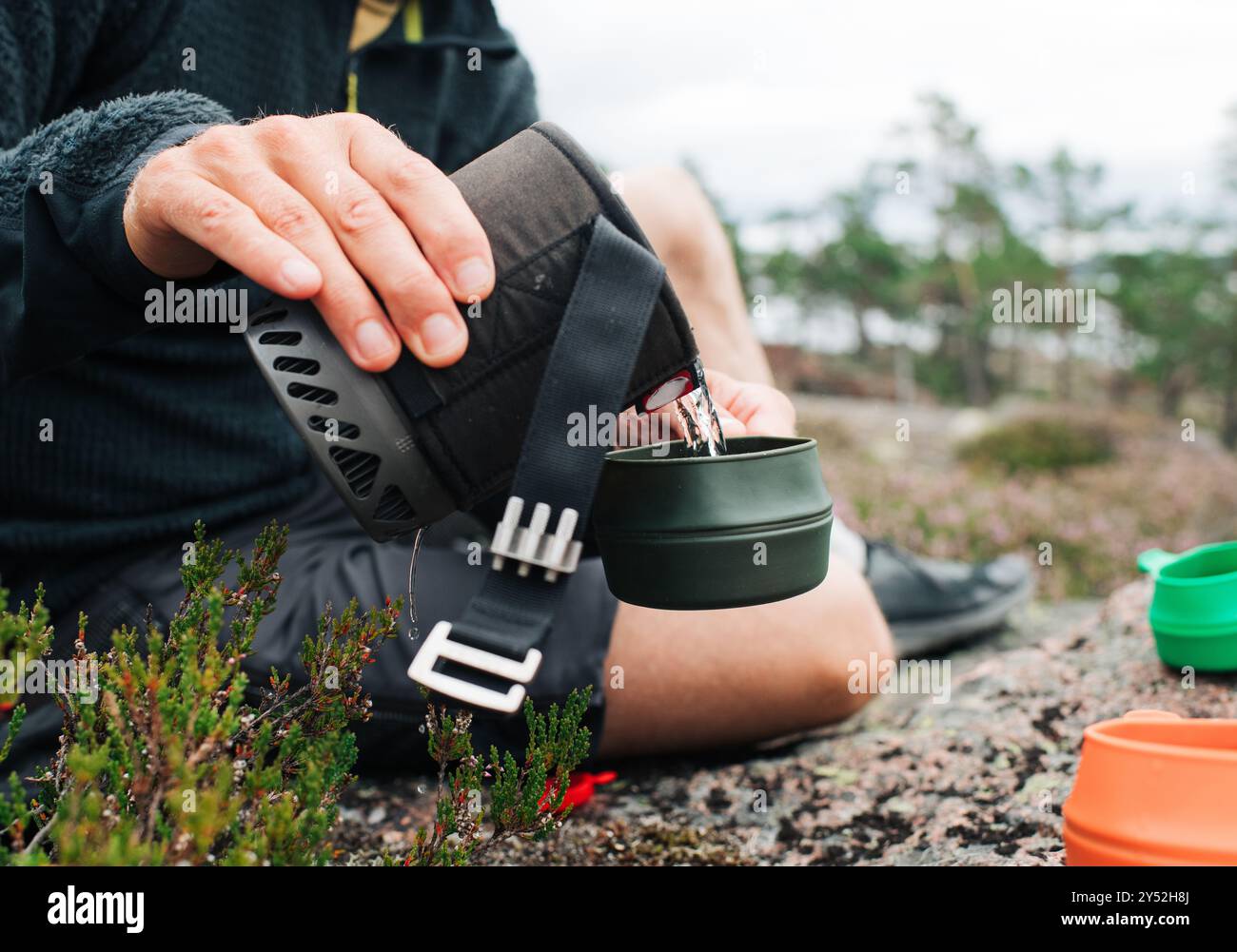 man pouring boiling water outdoors whilst hiking in Sweden Stock Photo ...