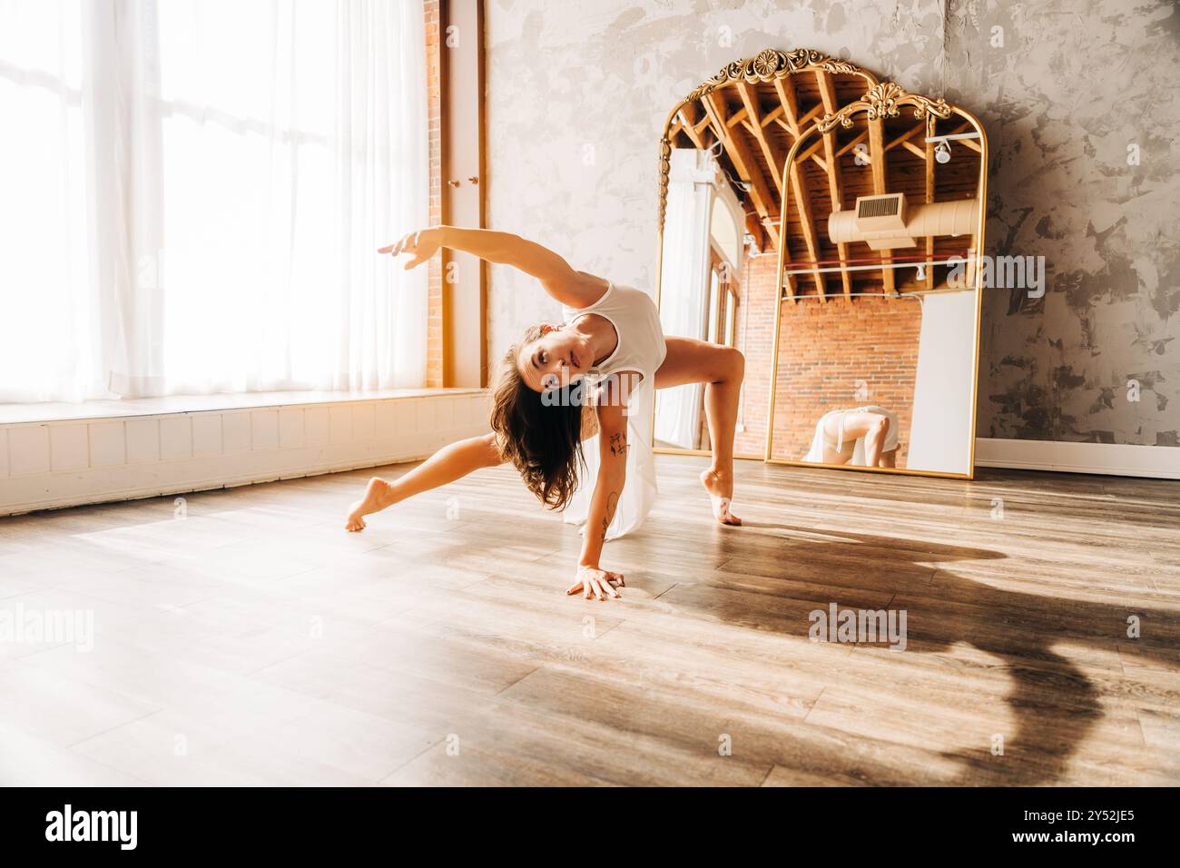 Ballet dancer in dynamic floor pose with extended arm Stock Photo - Alamy