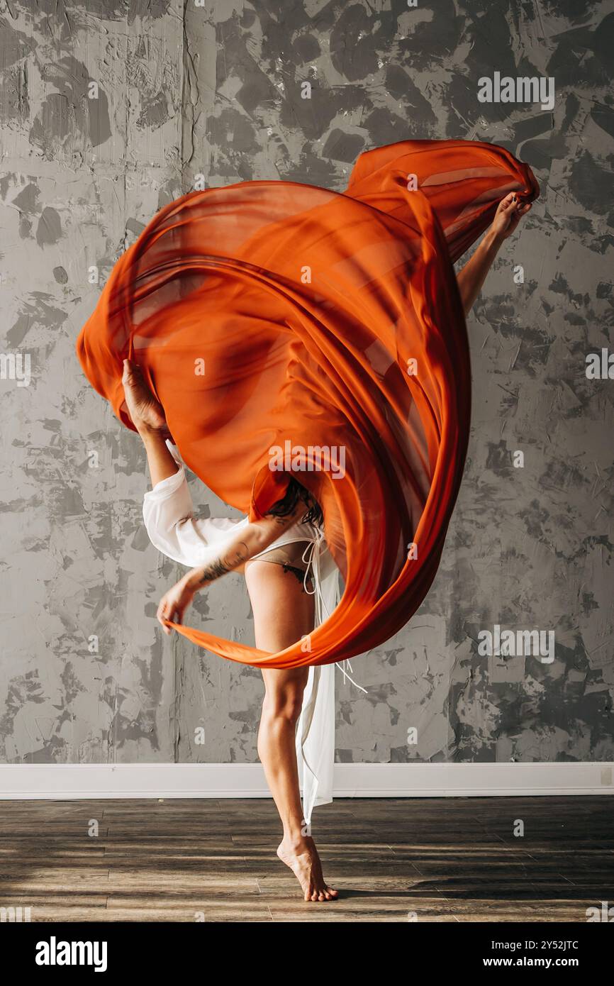 Ballet dancer with flowing red fabric gracefully performing Stock Photo ...
