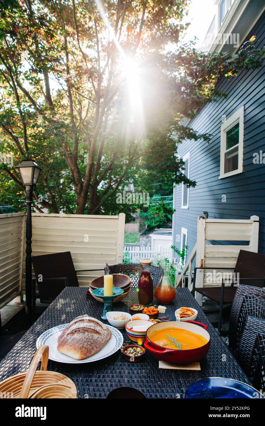 An outdoor fall feast with sunlight streaming in Stock Photo - Alamy