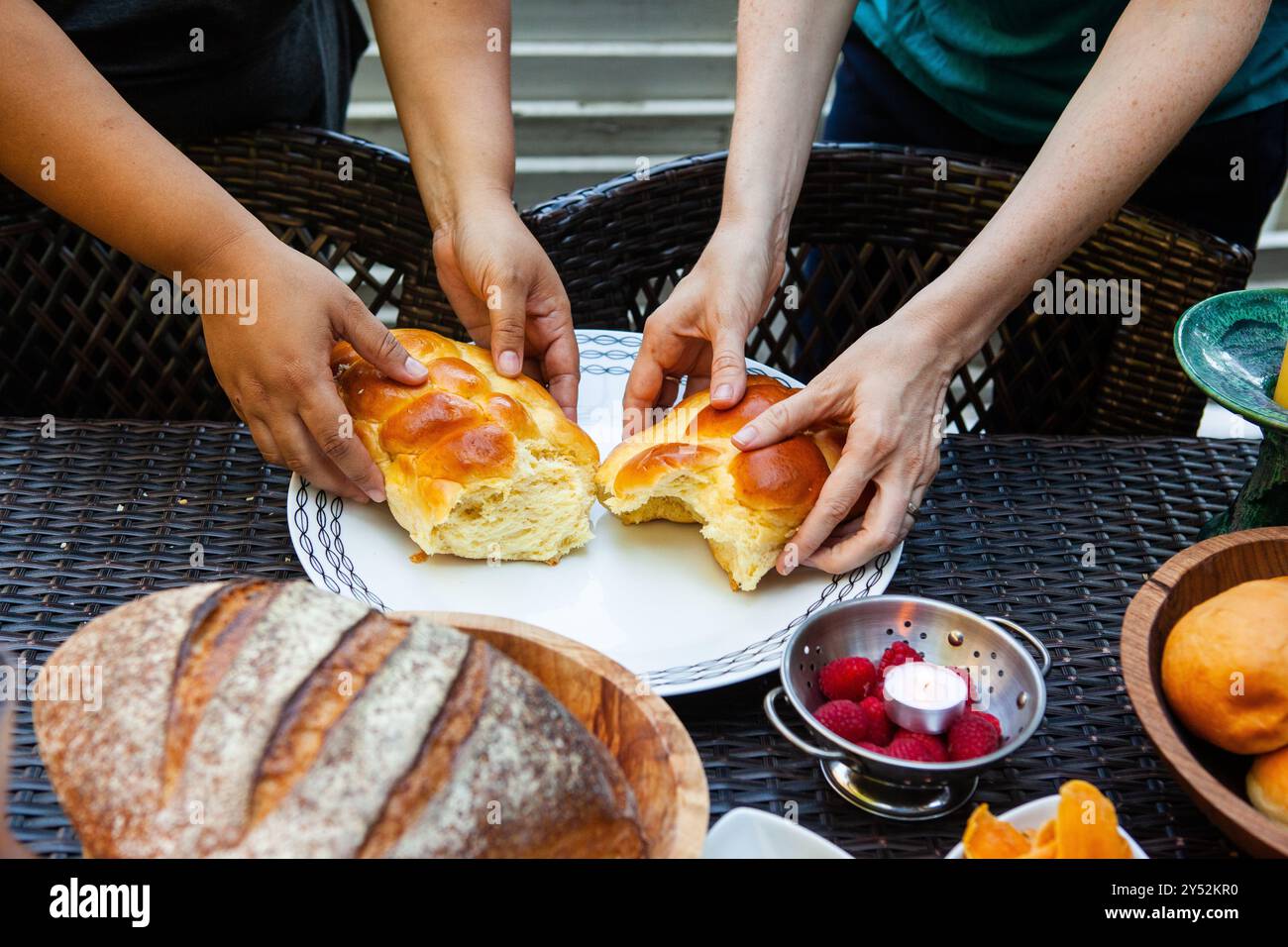 two diverse women break bread together Stock Photo - Alamy