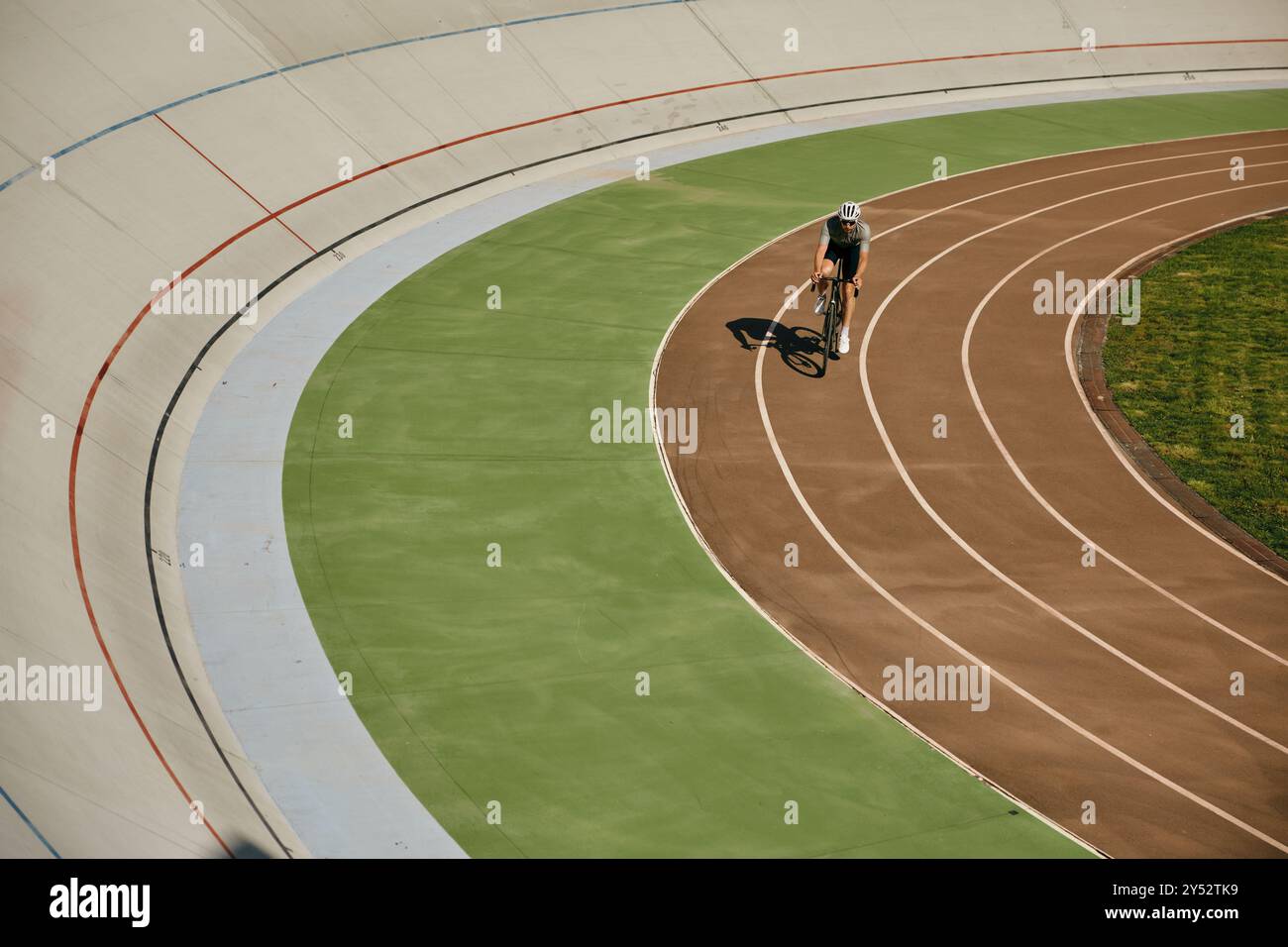 Man bicyclist enjoying training cycling on open velodrome track view ...