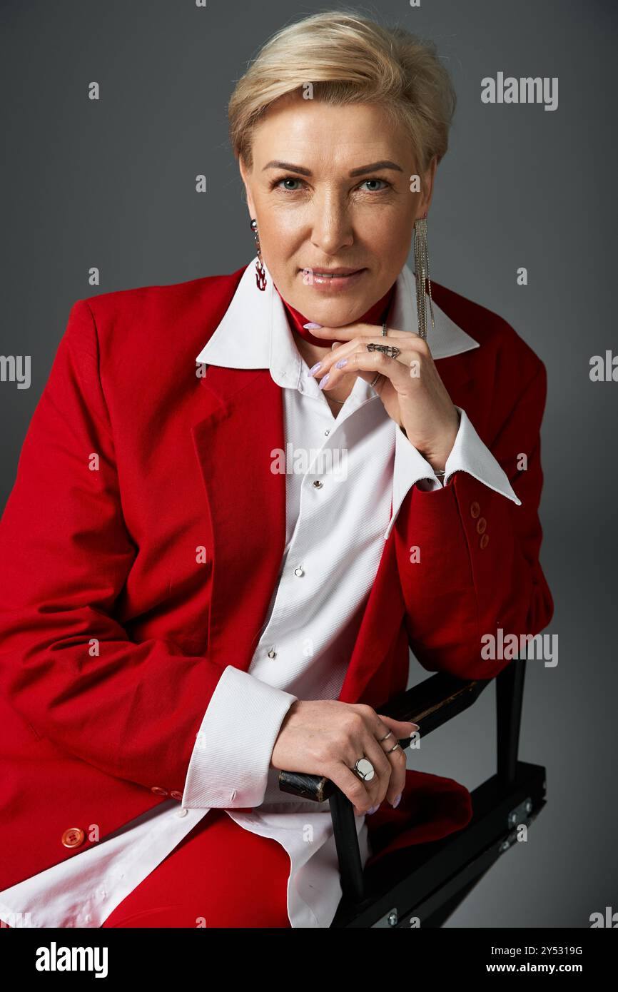 An elegant woman showcases her fashion sense with a striking red suit ...