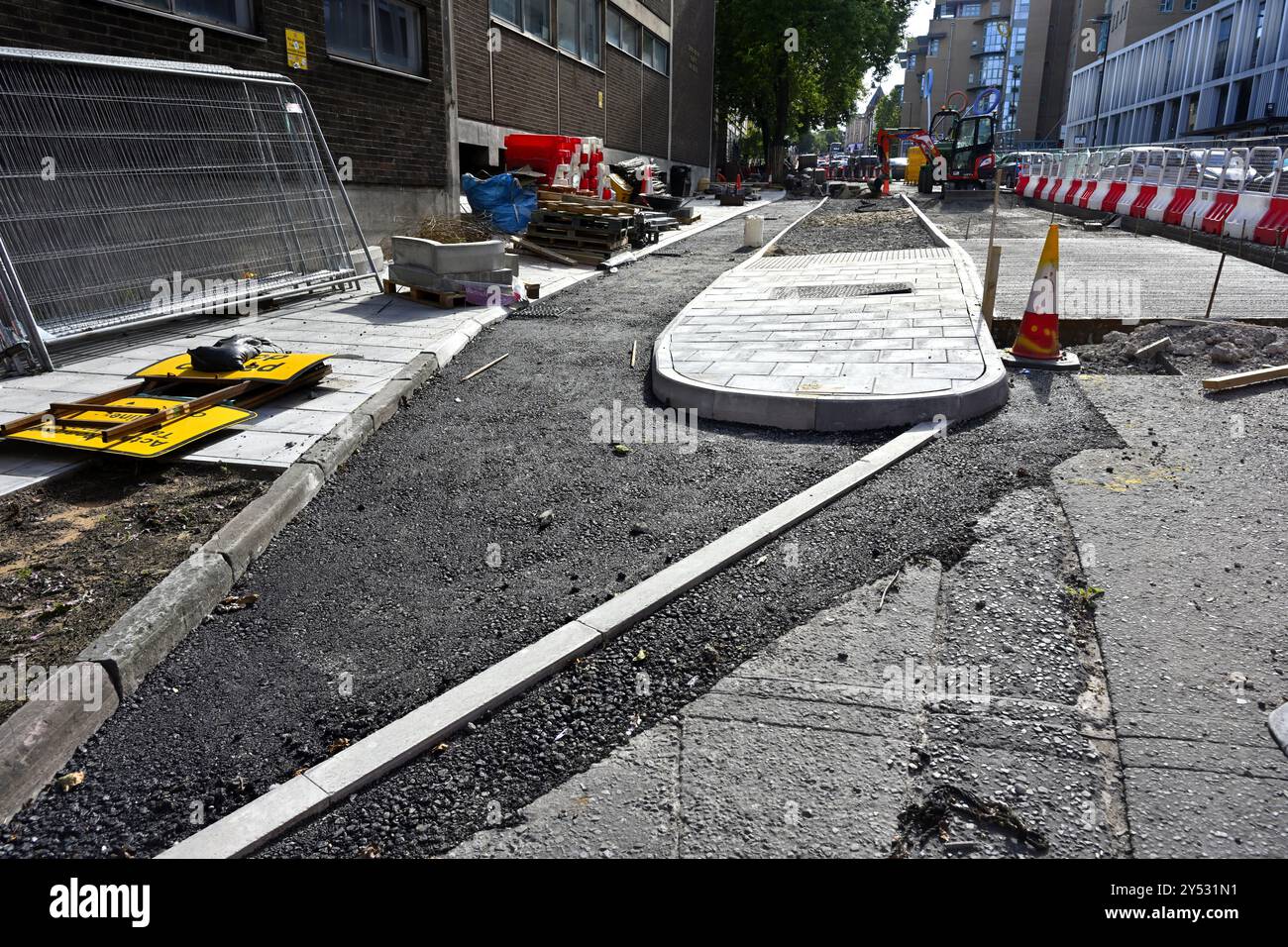 Roadworks, building a "floating bus stop" cycle bypass lane in pavement ...