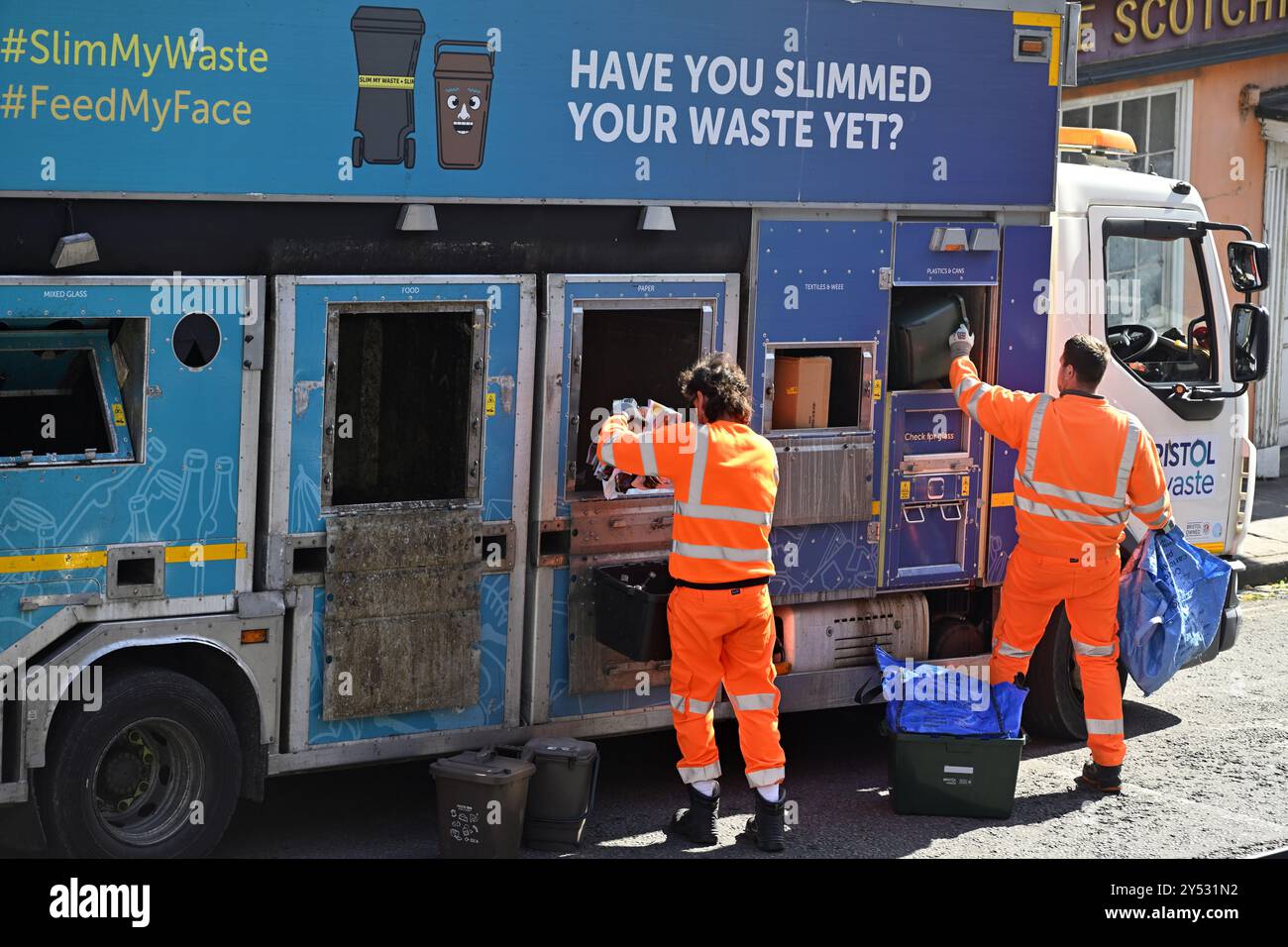 Recycling collection of sorting bags and boxes by two council workers ...