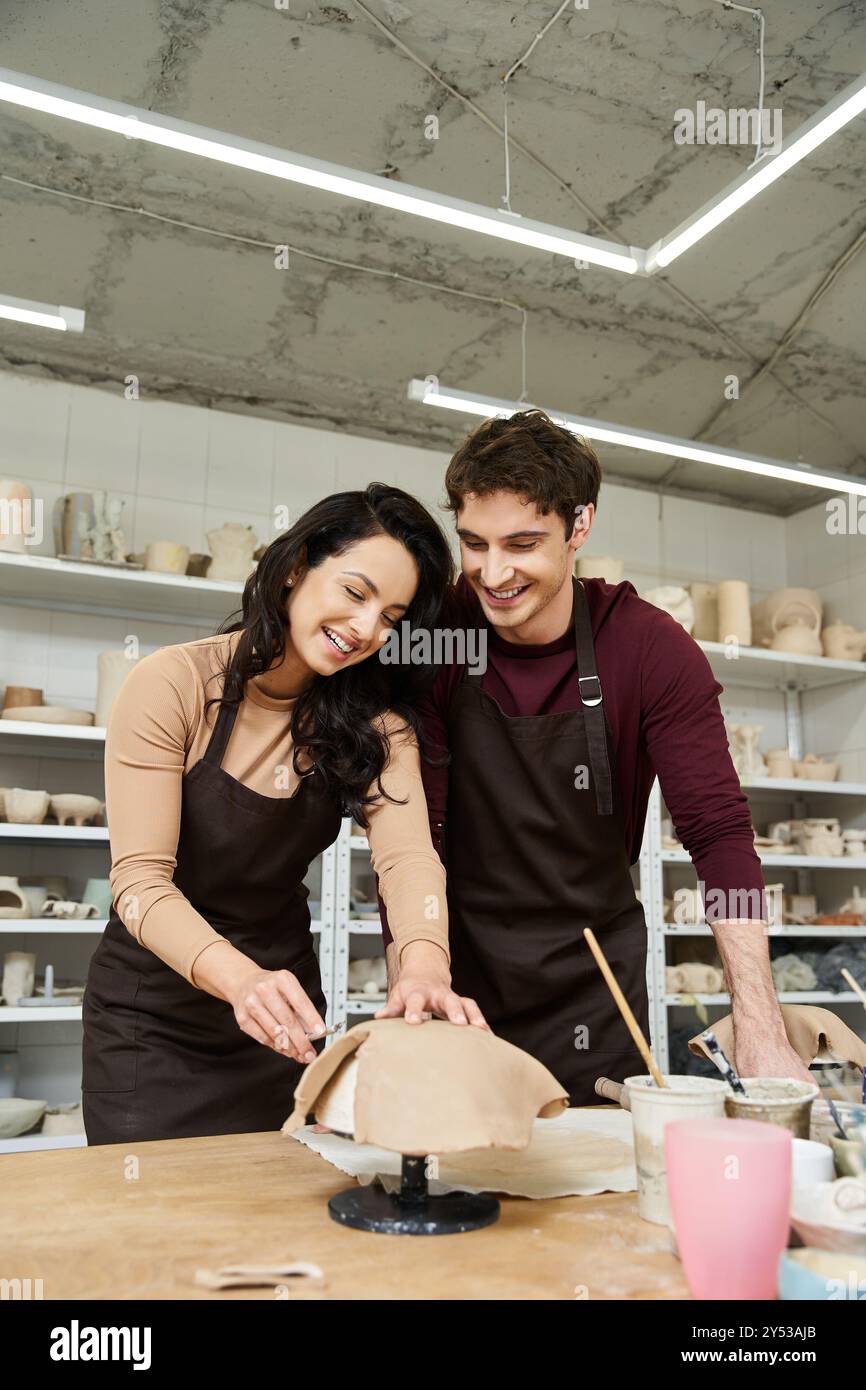 A loving couple shapes clay during a pottery session in a contemporary ...